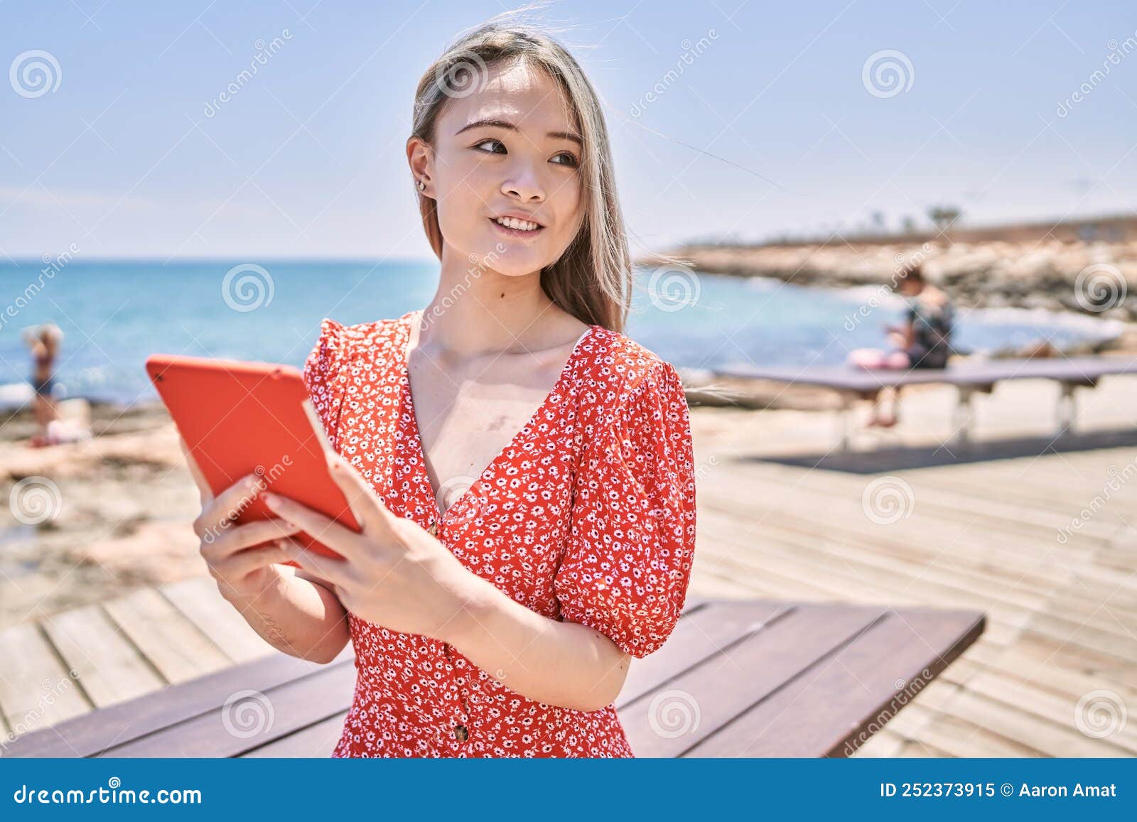 Young Chinese Girl Smiling Happy Using Touchpad at the Beach Stock ...