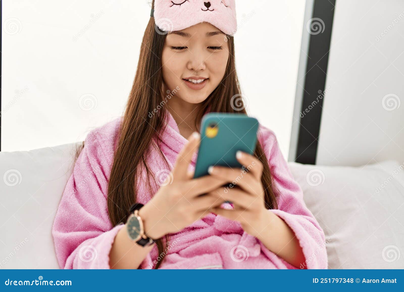 Young Chinese Girl Using Smartphone Lying on the Bed at Bedroom Stock ...