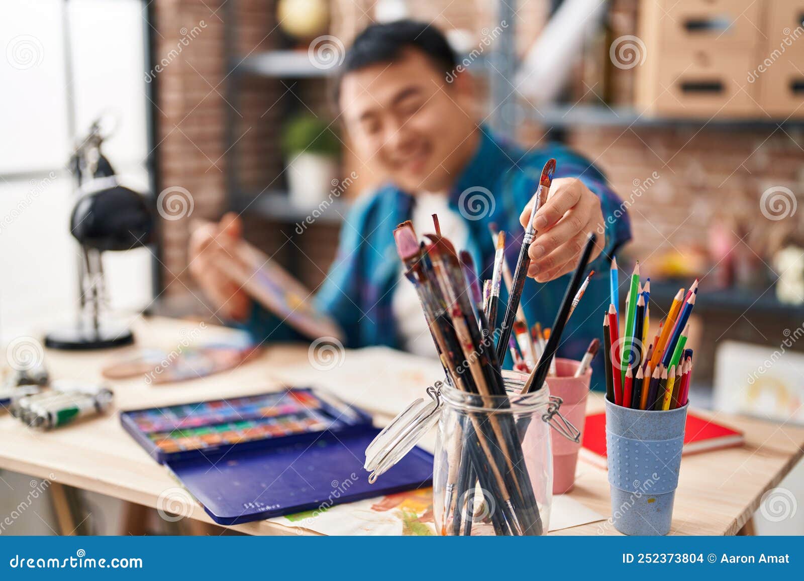 Young Chinese Man Artist Drawing on Notebook at Art Studio Stock Photo ...