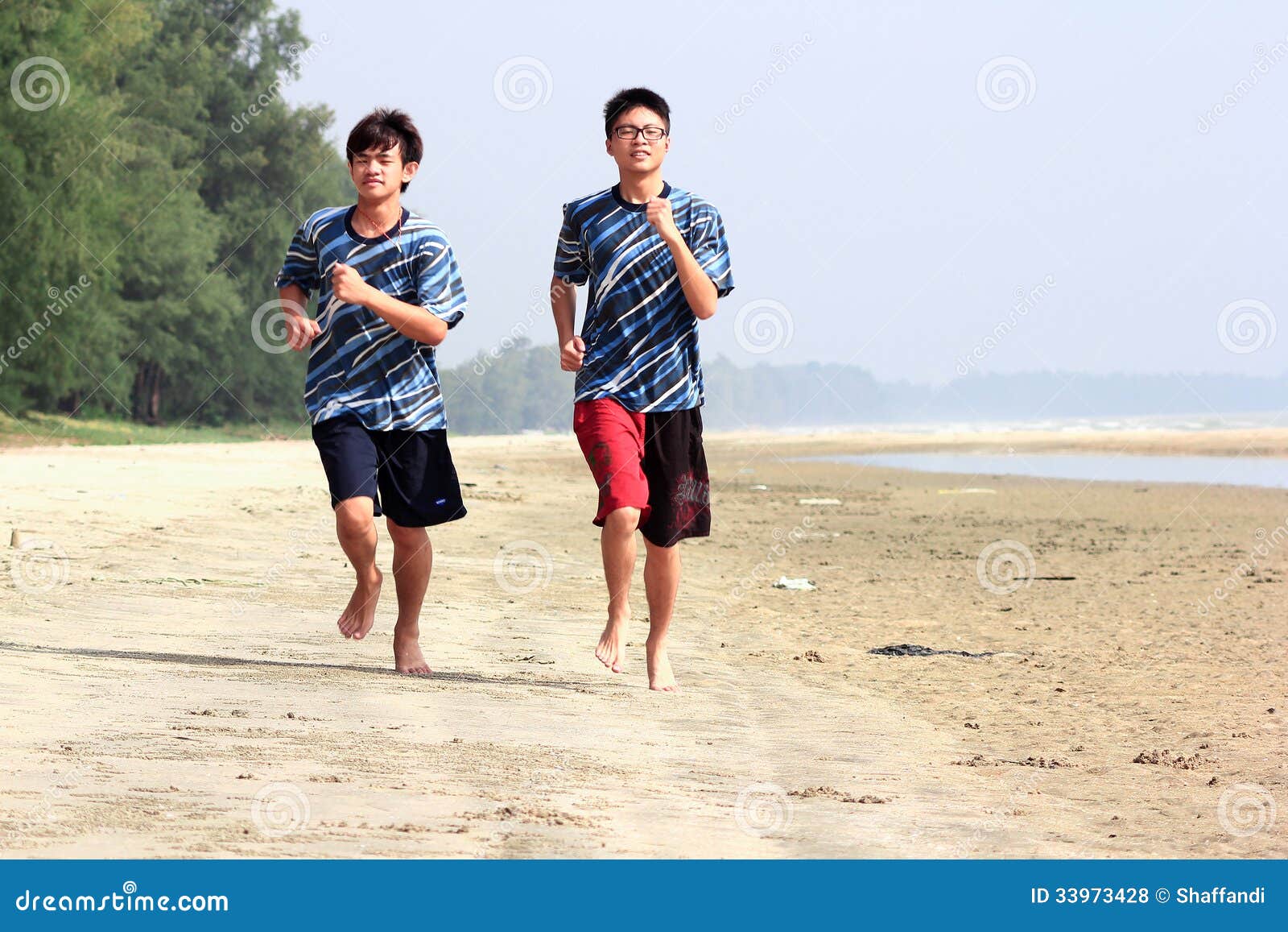 Young Chinese Man Jogging on the Beach Stock Photo - Image of male ...