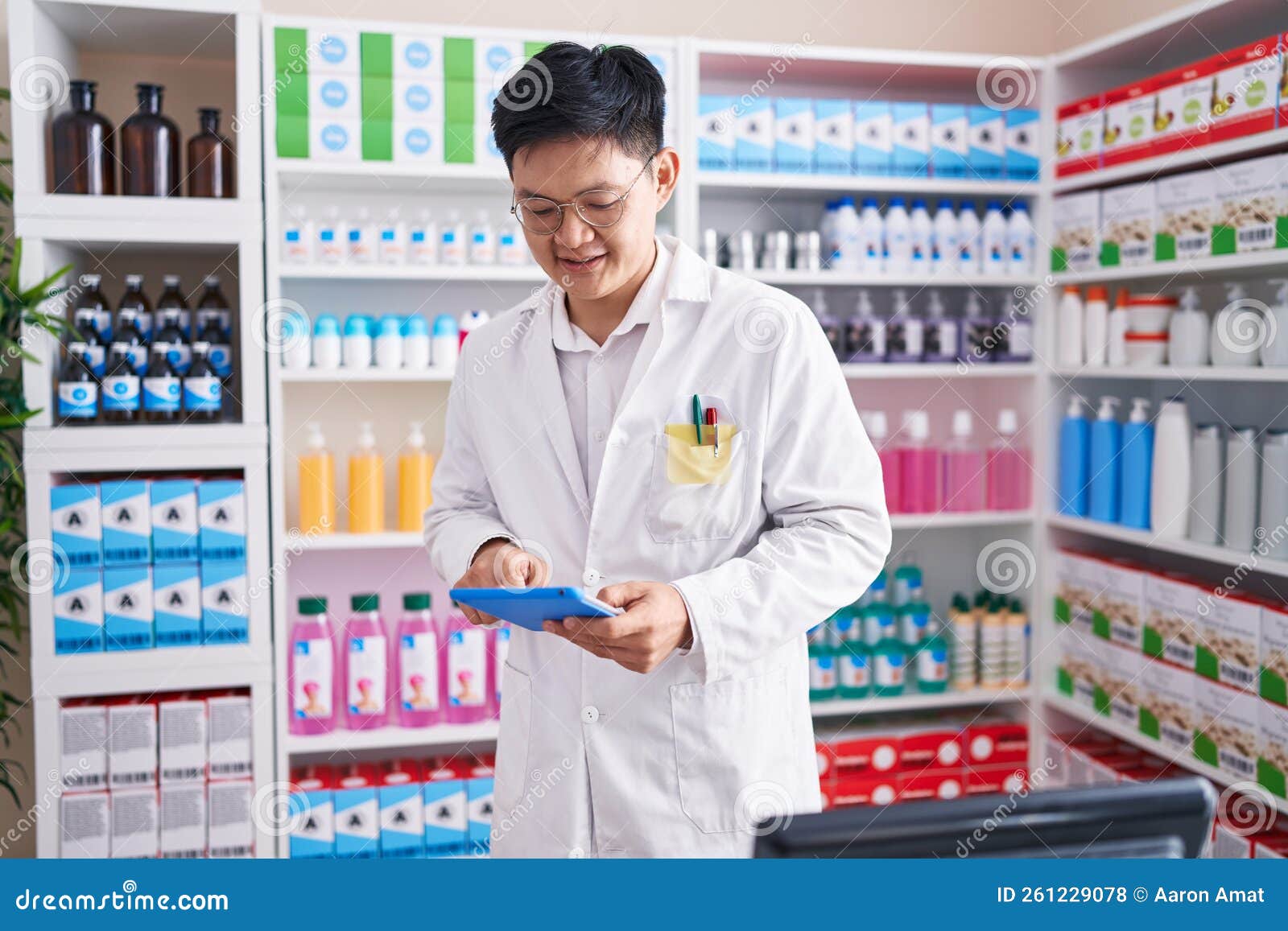 Young Chinese Man Pharmacist Using Touchpad Working at Pharmacy Stock ...