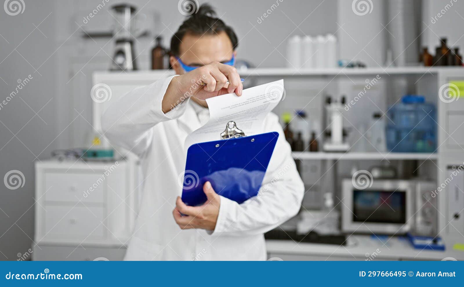 Young Chinese Man Scientist Taking Notes on Checklist at Laboratory ...