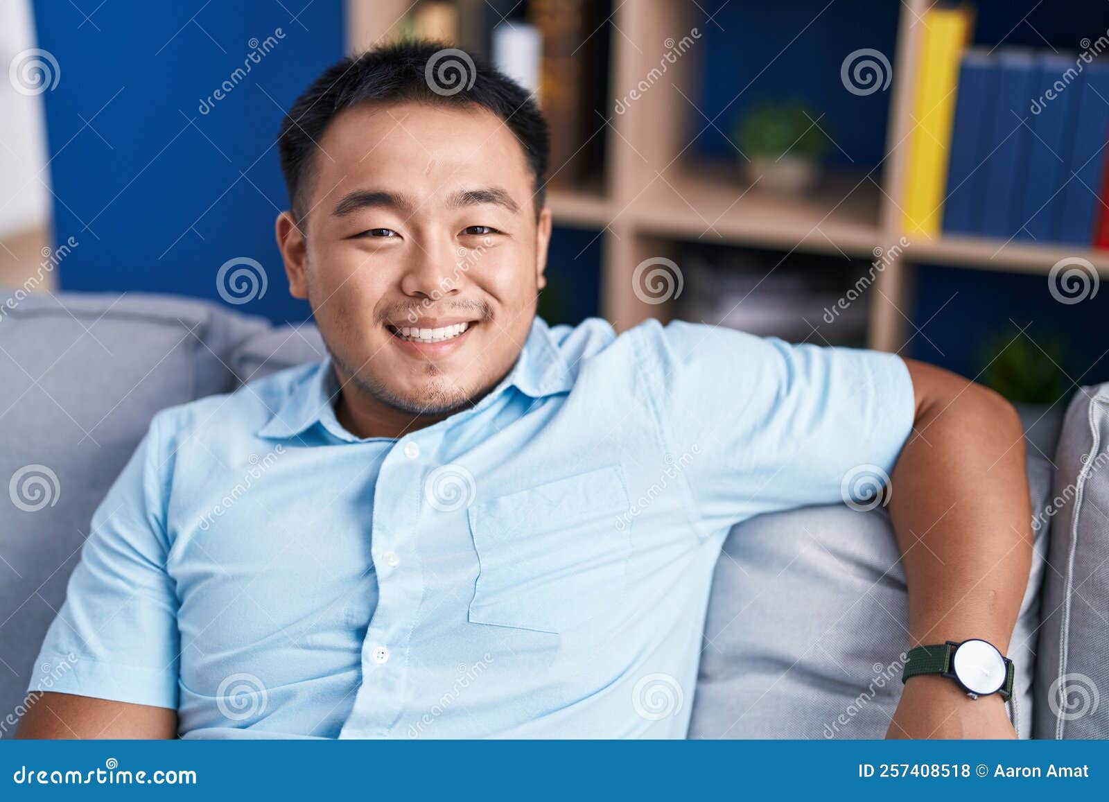 Young Chinese Man Smiling Confident Sitting on Sofa at Home Stock Photo ...