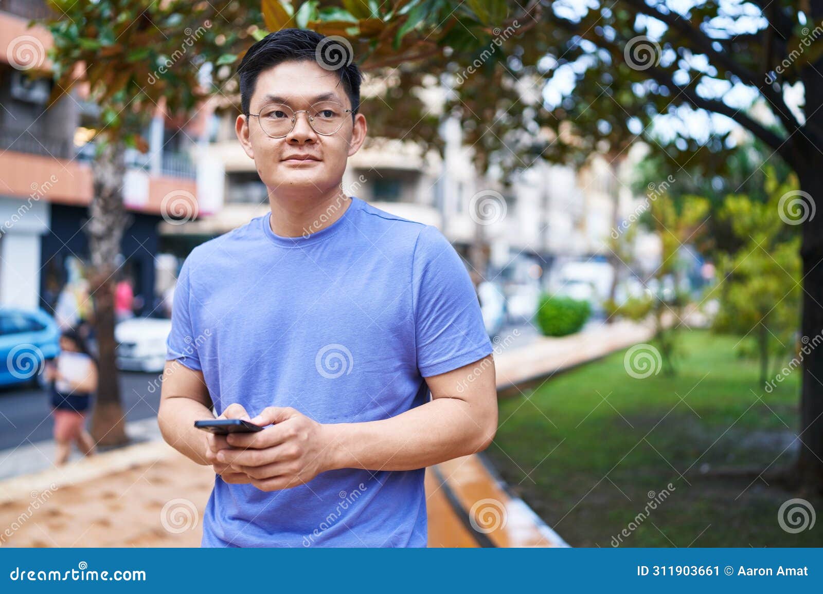 Young Chinese Man Smiling Confident Using Smartphone at Park Stock ...