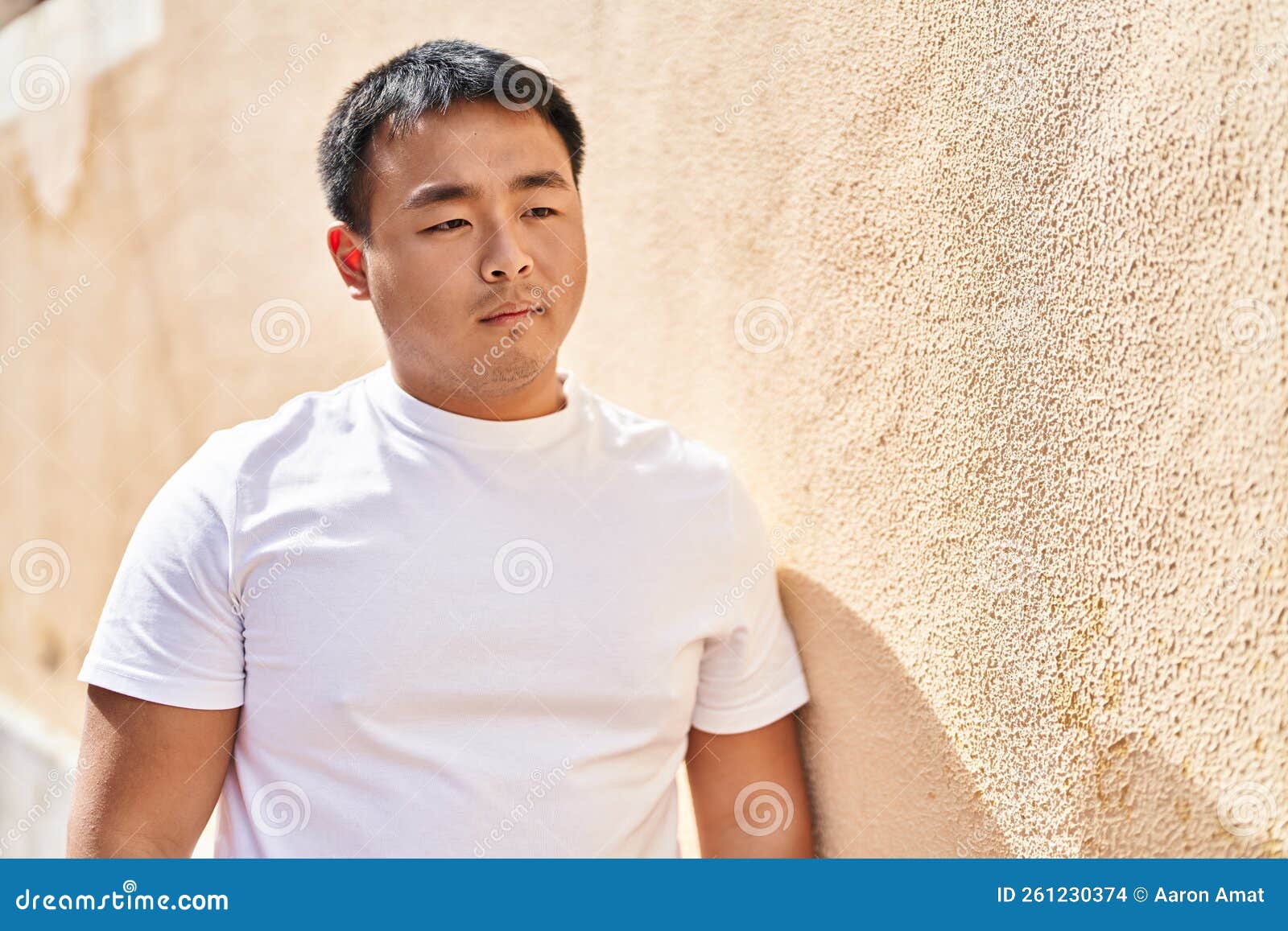 Young Chinese Man Standing with Relaxed Expression at Street Stock ...