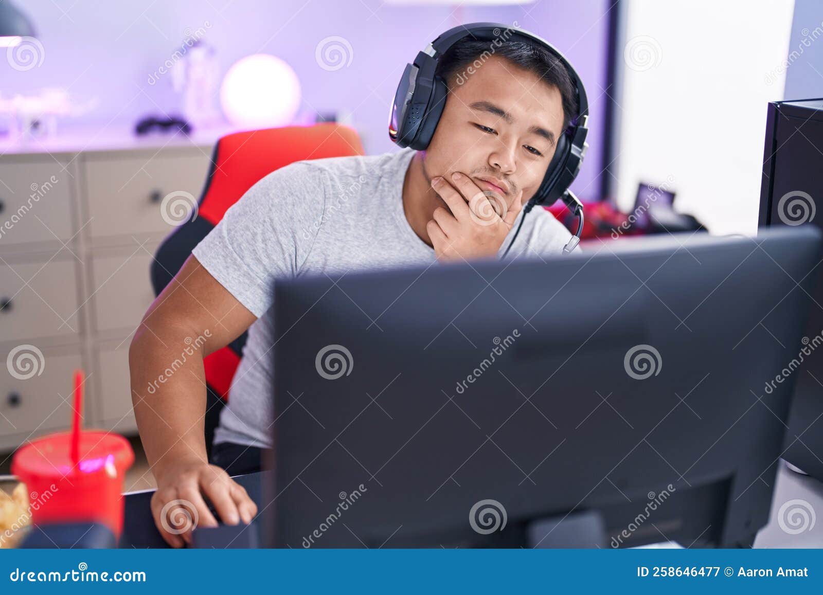 Young Chinese Man Streamer Playing Video Game Using Computer at Gaming ...