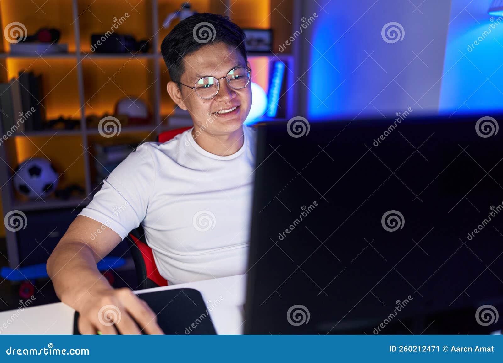 Young Chinese Man Streamer Playing Video Game Using Computer at Gaming ...