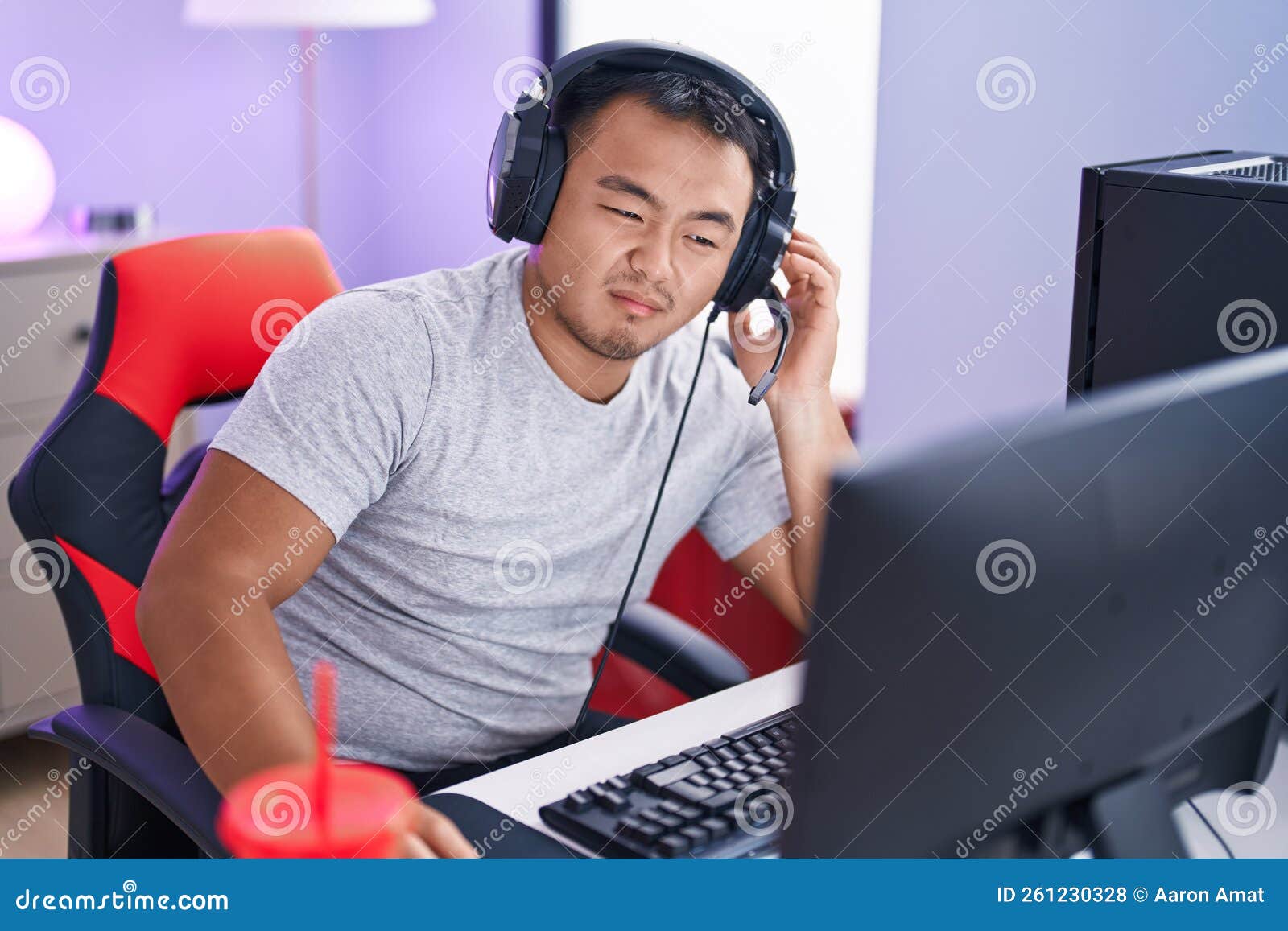 Young Chinese Man Streamer Playing Video Game Using Computer at Gaming ...