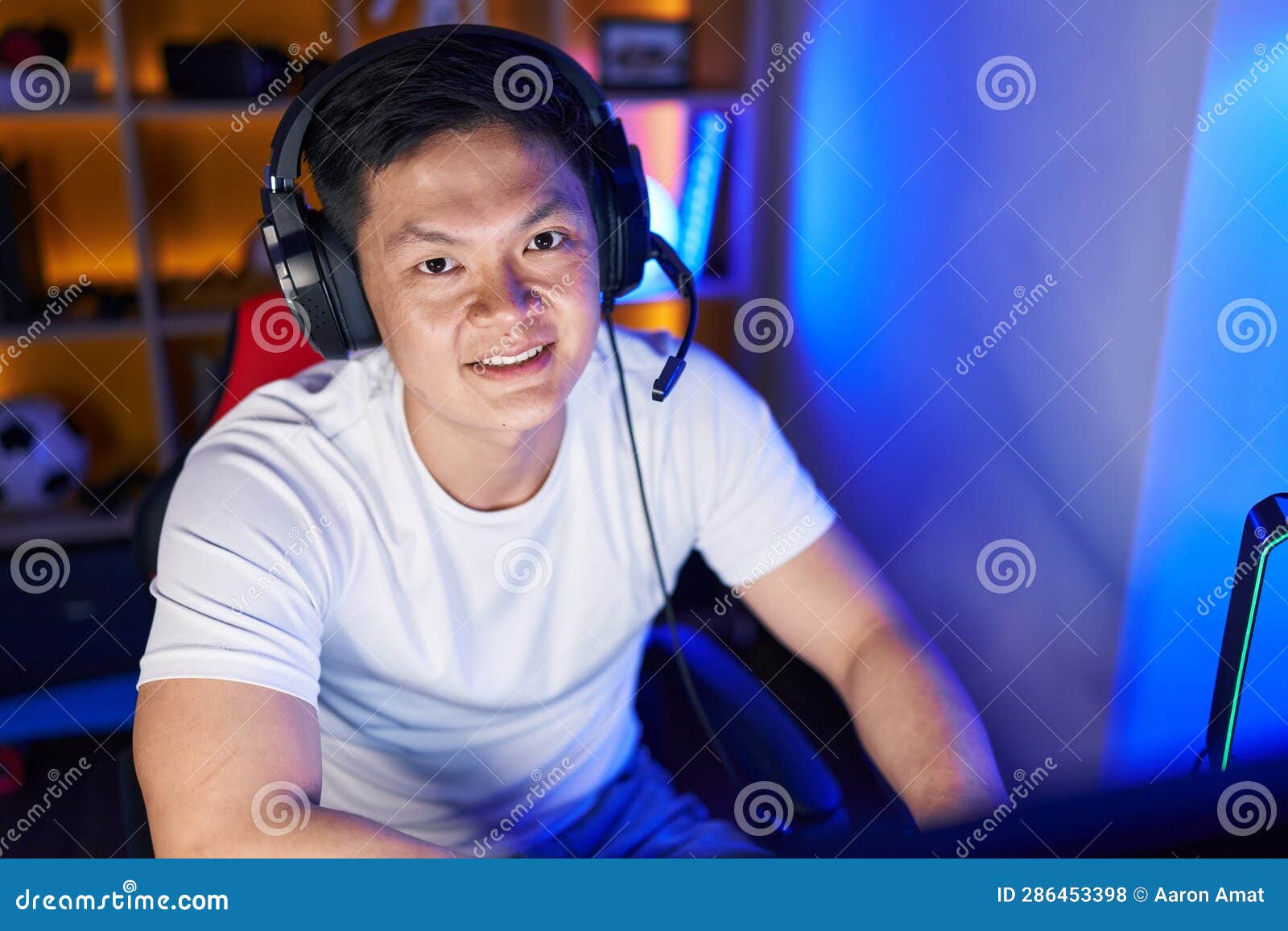 Young Chinese Man Streamer Playing Video Game Using Computer at Gaming ...