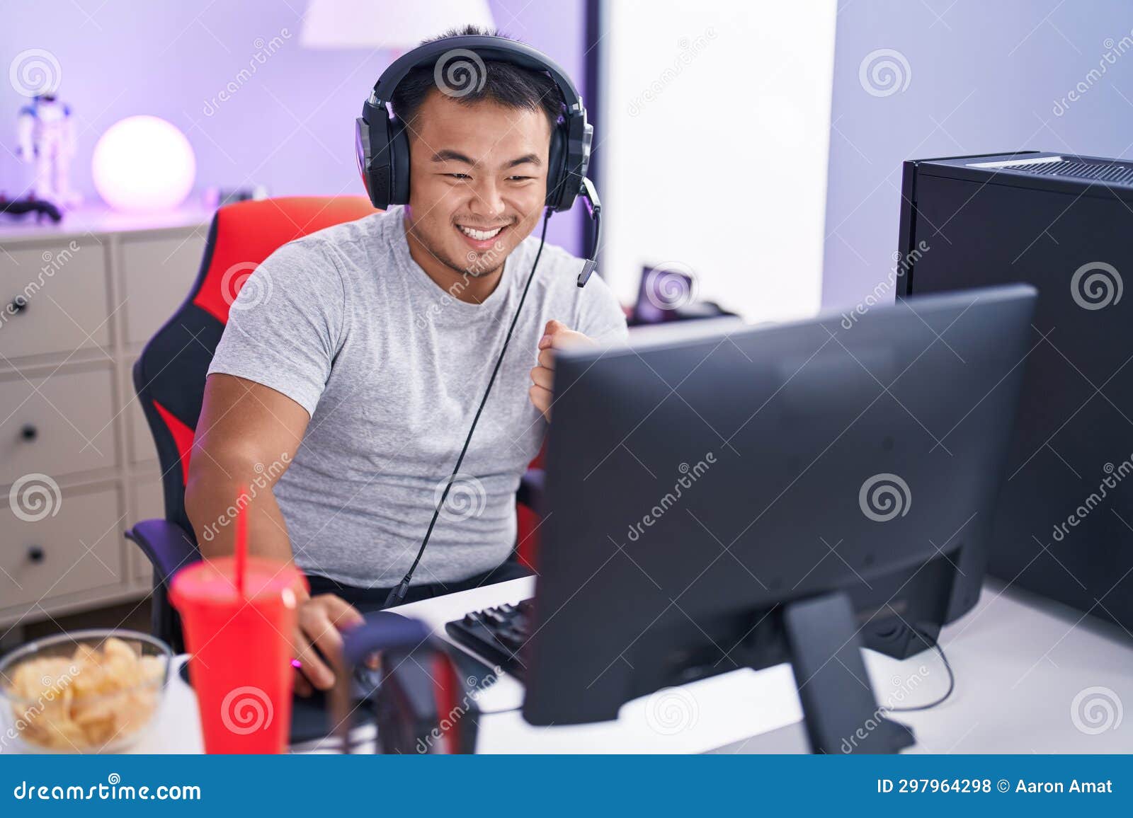 Young Chinese Man Streamer Playing Video Game Using Computer at Gaming ...