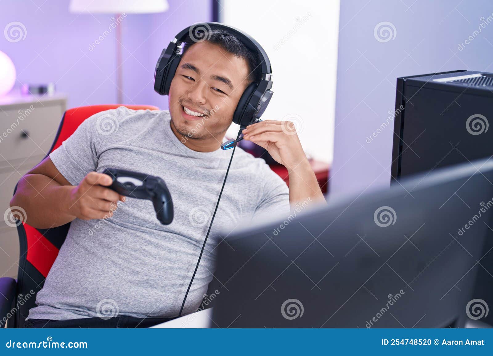 Young Chinese Man Streamer Playing Video Game Using Joystick at Gaming ...