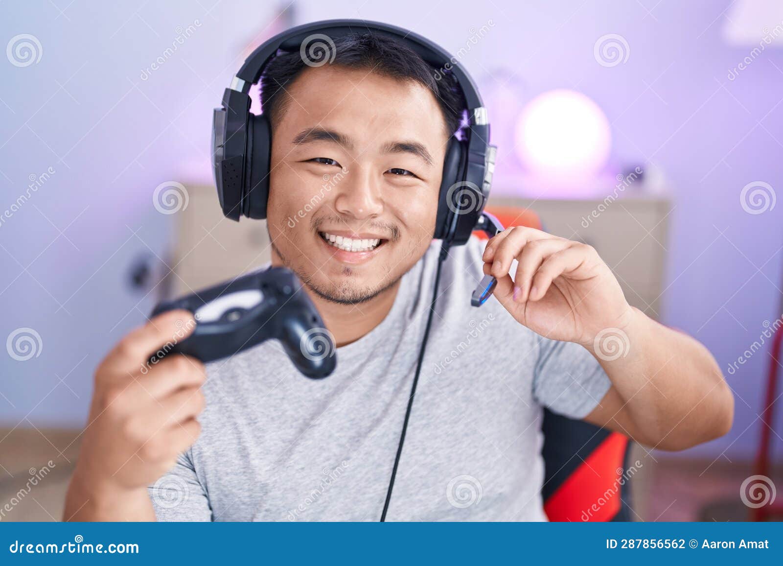 Young Chinese Man Streamer Playing Video Game Using Joystick at Gaming ...