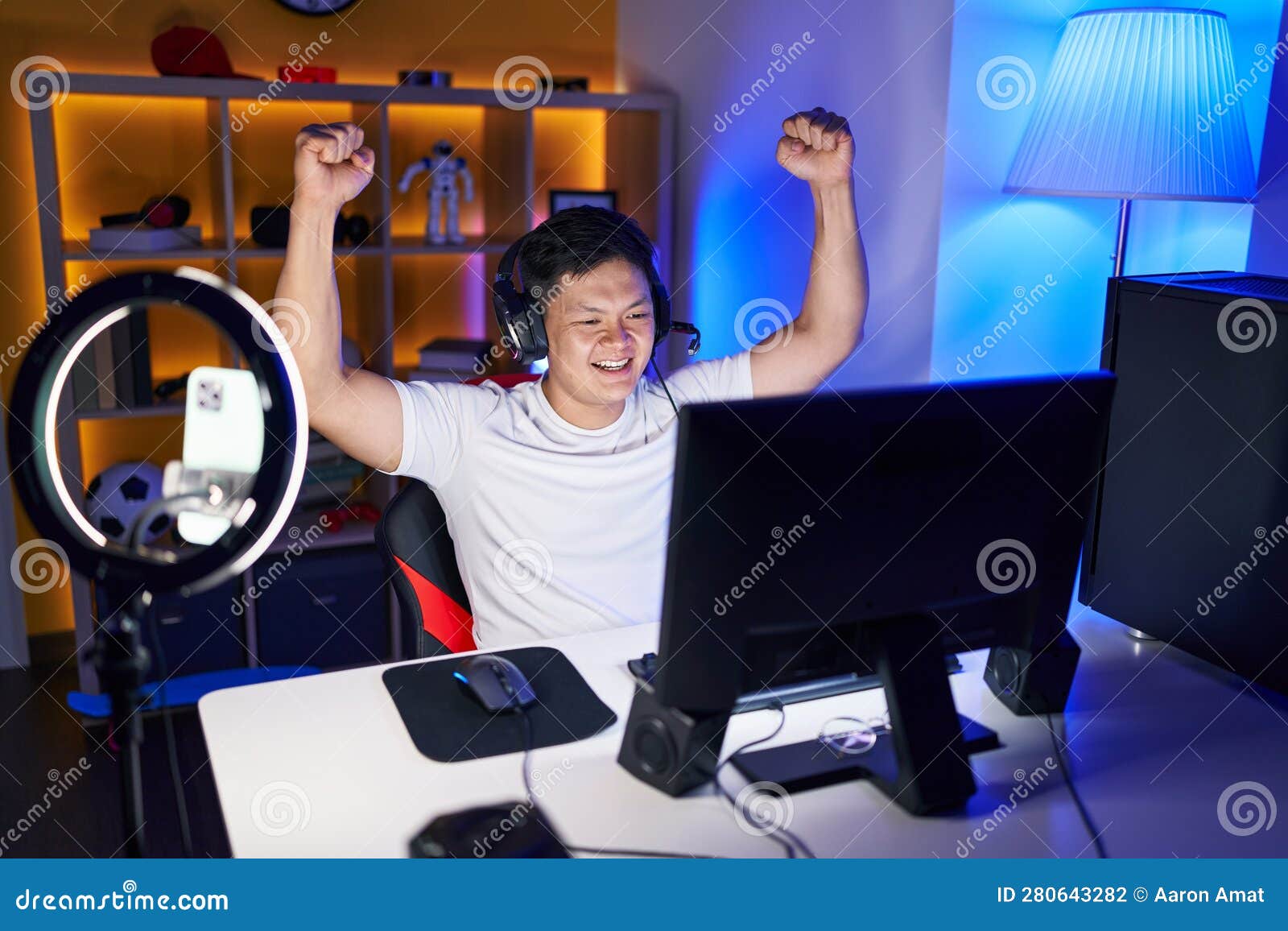 Young Chinese Man Streamer Playing Video Game with Winner Expression at ...