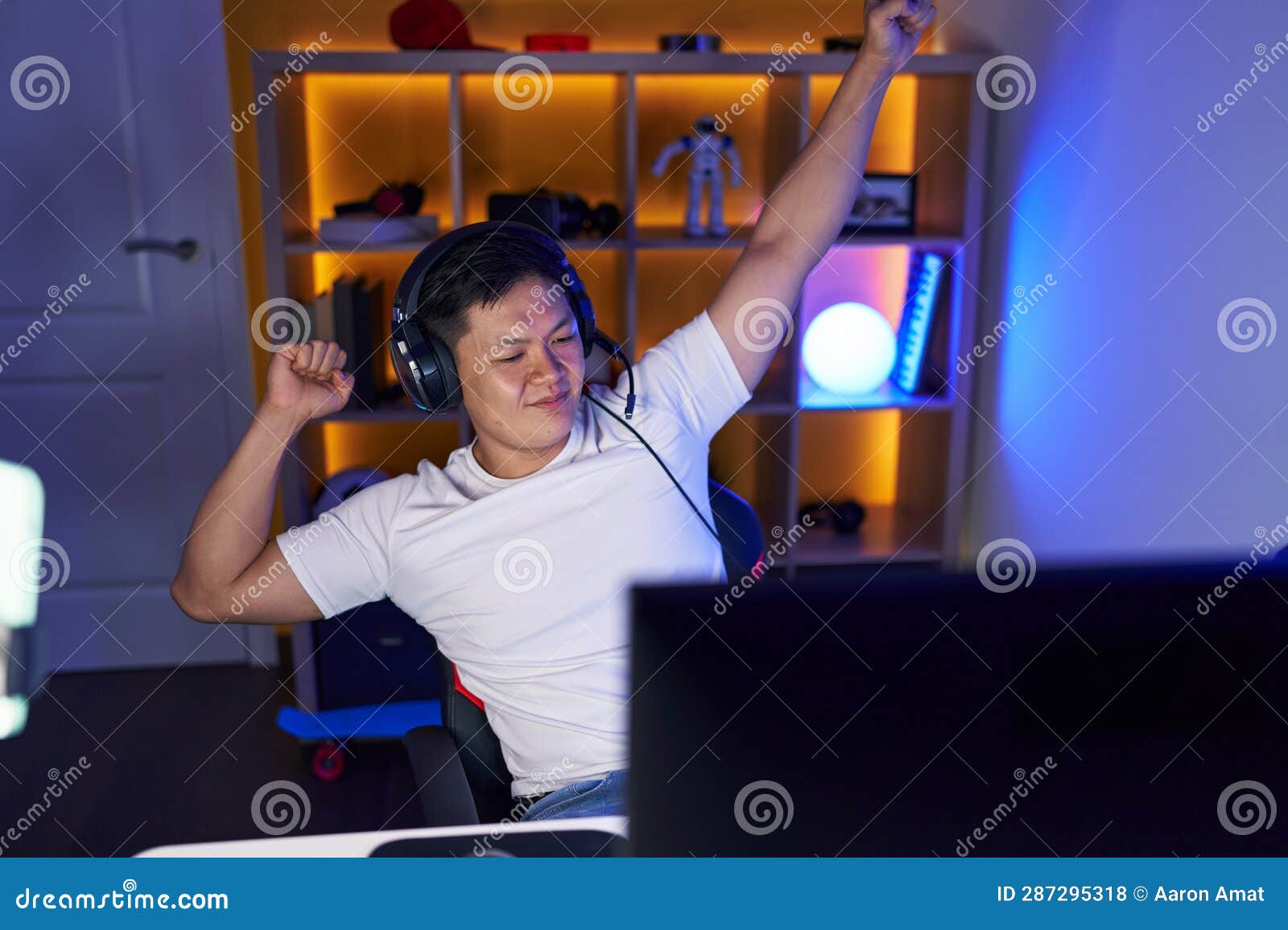 Young Chinese Man Streamer Playing Video Game with Winner Expression at ...