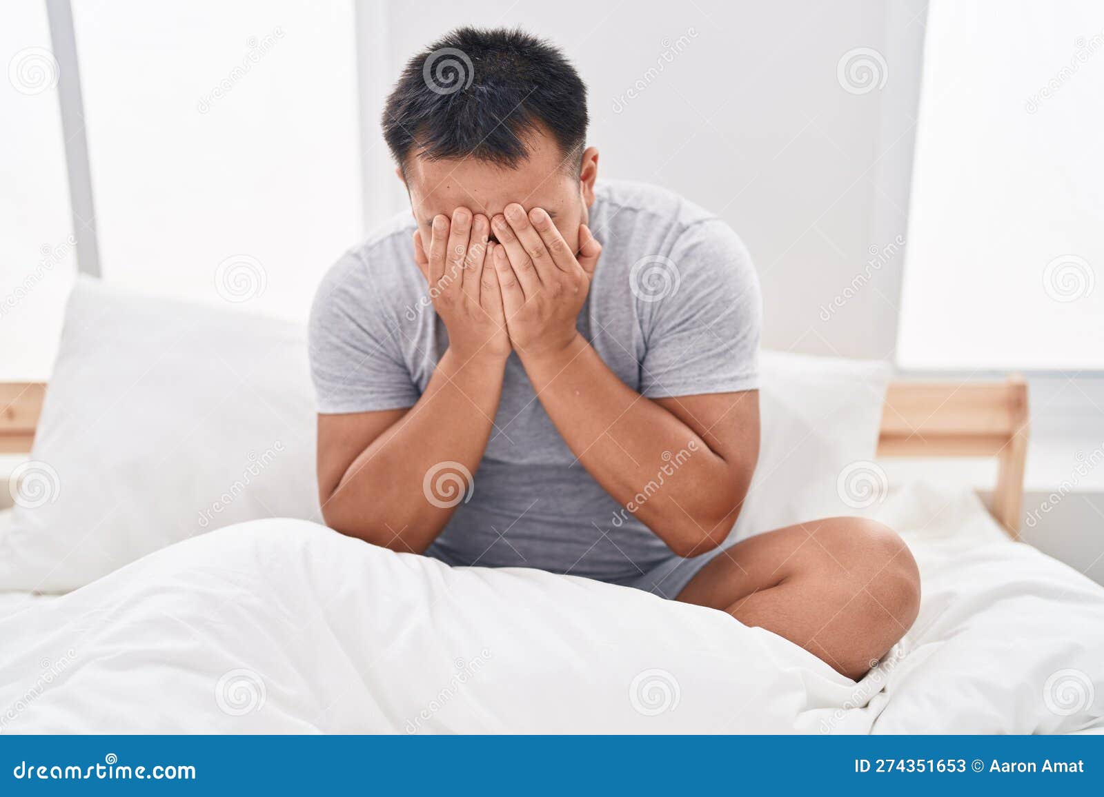 Young Chinese Man Stressed Sitting on Bed at Bedroom Stock Image ...