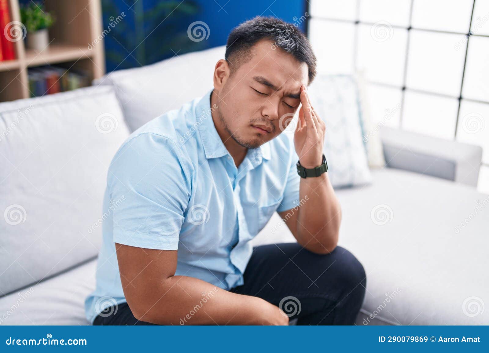 Young Chinese Man Stressed Sitting on Sofa at Home Stock Image - Image ...