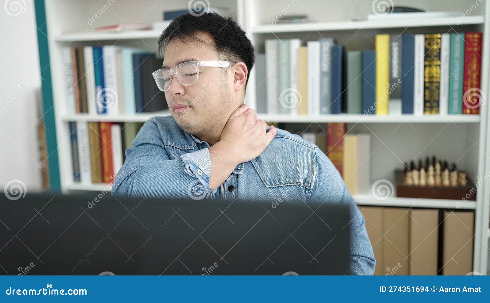 Young Chinese Man Student Using Computer Stressed at Library University ...