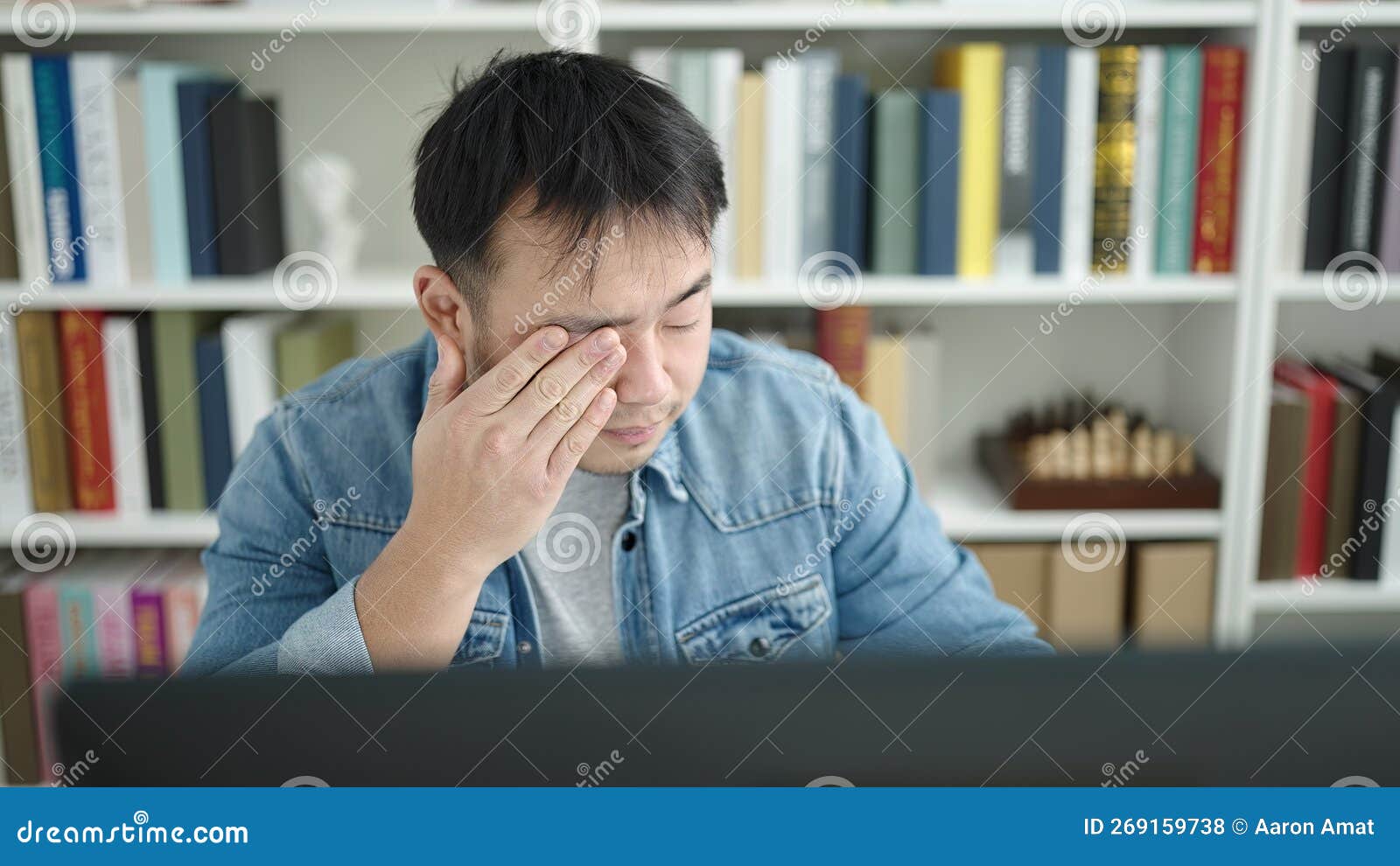 Young Chinese Man Student Using Computer Stressed at Library University ...
