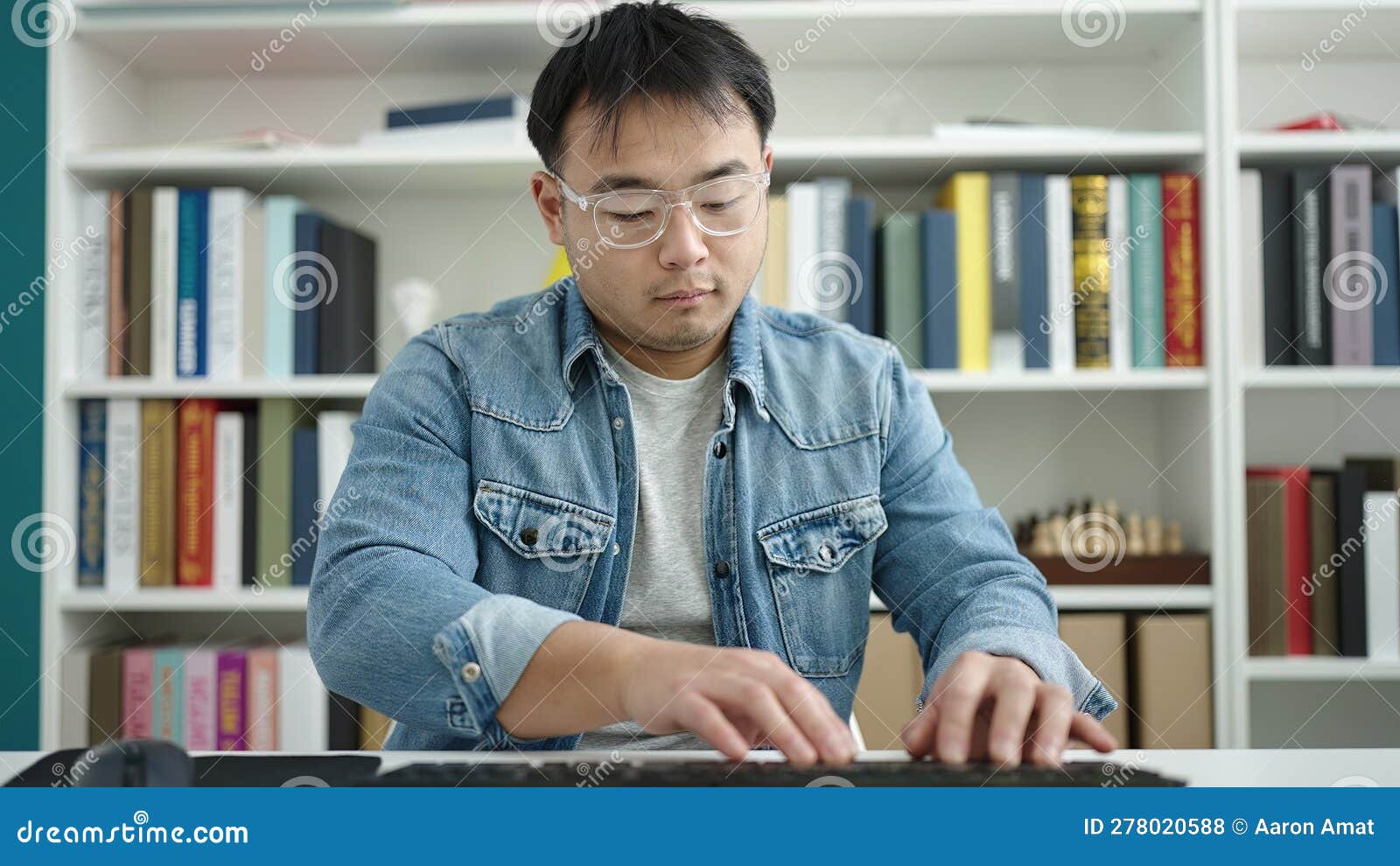Young Chinese Man Student Using Computer Studying at Library University ...