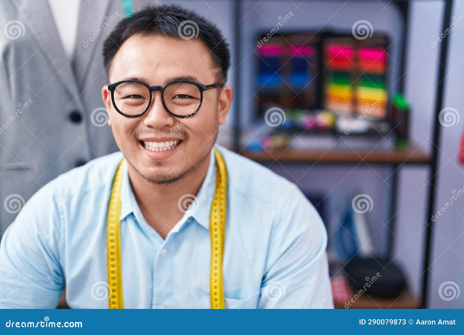Young Chinese Man Tailor Smiling Confident Sitting on Table at Tailor ...