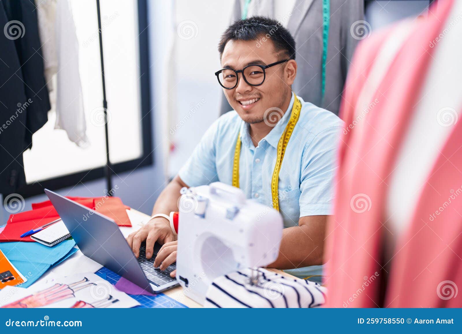 Young Chinese Man Tailor Smiling Confident Using Laptop at Tailor Shop ...