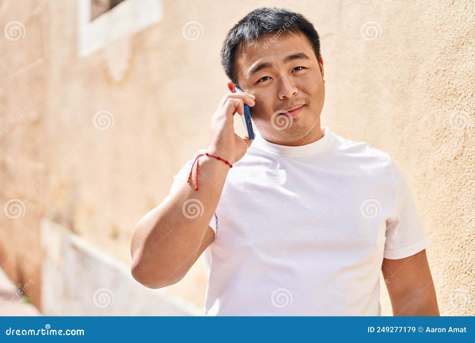 Young Chinese Man Talking on the Smartphone at Street Stock Image ...