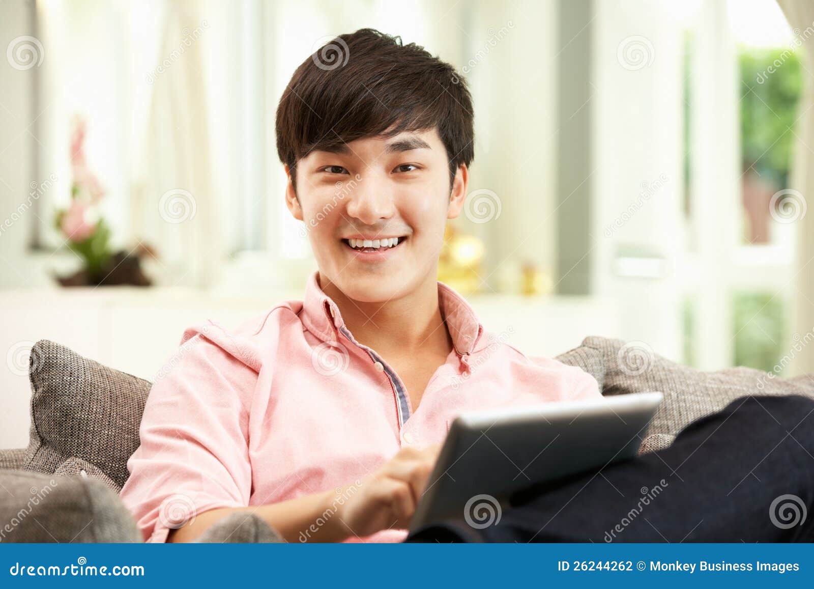 Young Chinese Man Using Digital Tablet Stock Photo - Image of sitting ...