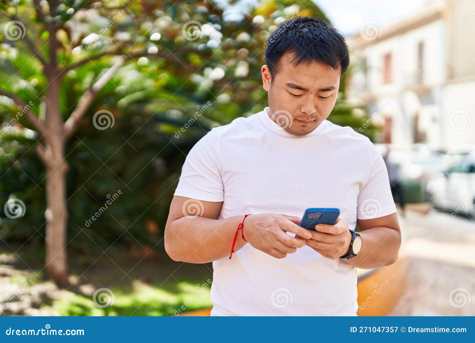 Young Chinese Man Using Smartphone at Park Stock Image - Image of ...
