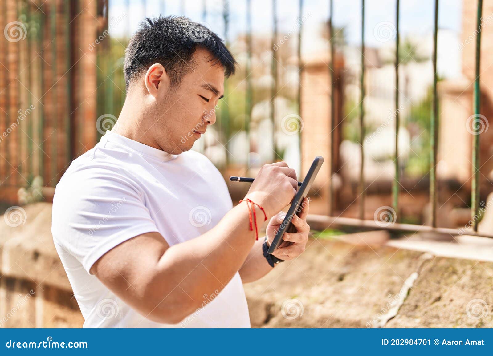 Young Chinese Man Using Touchpad at Street Stock Image - Image of ...