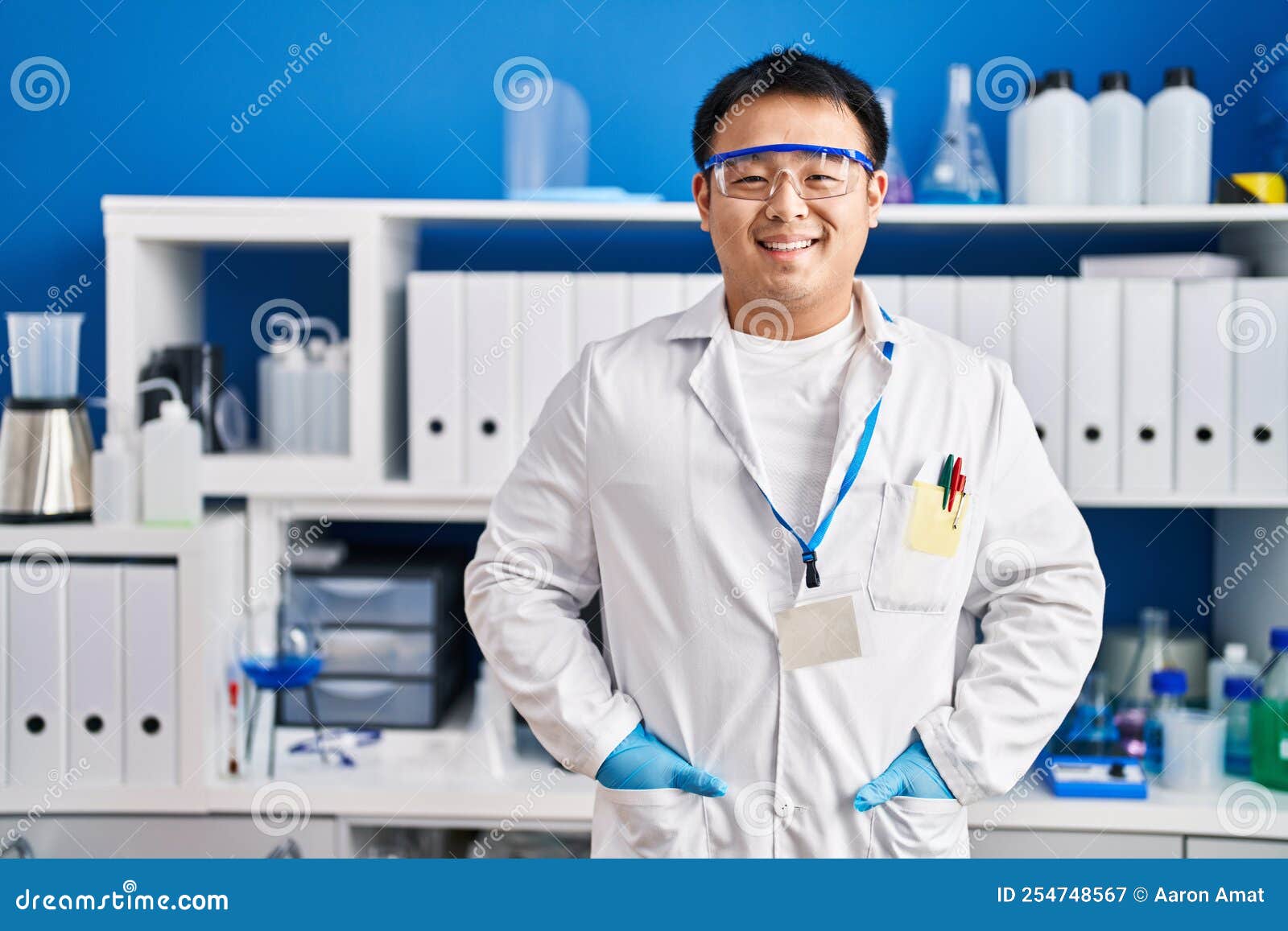 Young Chinese Man Wearing Scientist Uniform Standing at Laboratory ... Young Chinese Man Wearing Scientist Uniform Standing at Laboratory ...