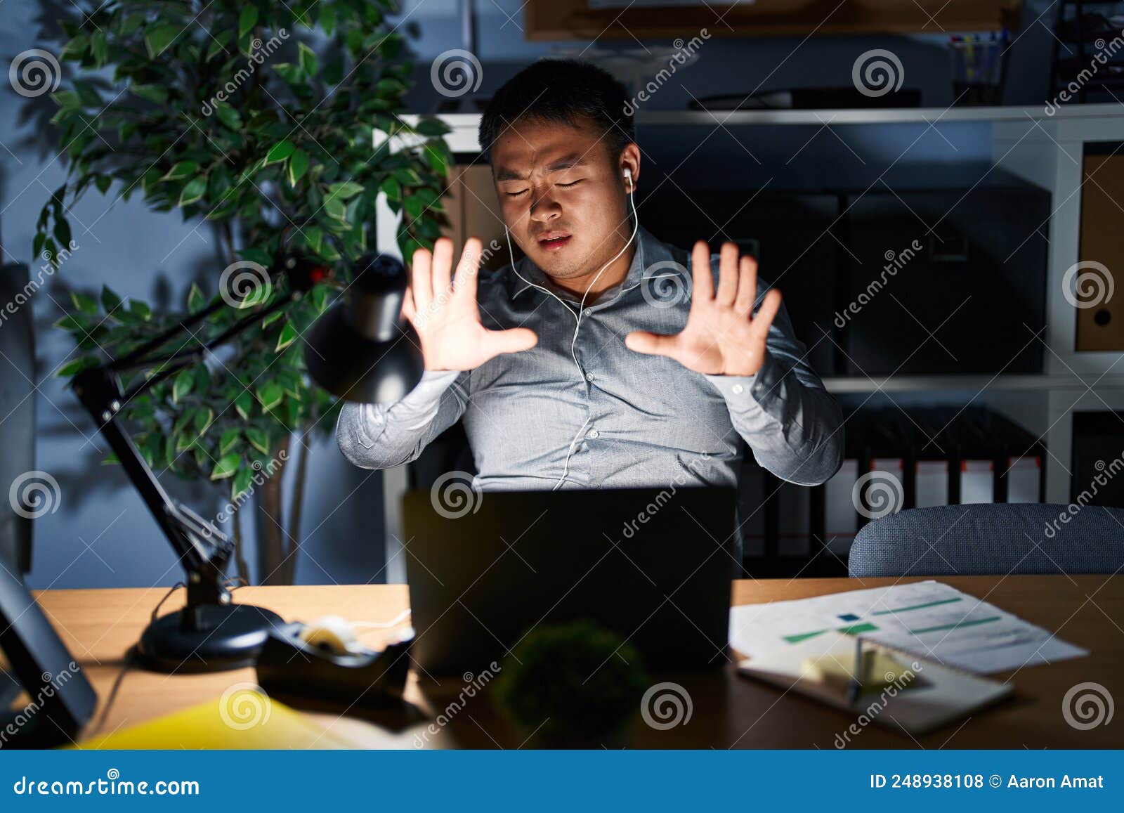 Young Chinese Man Working Using Computer Laptop at Night Afraid and ...
