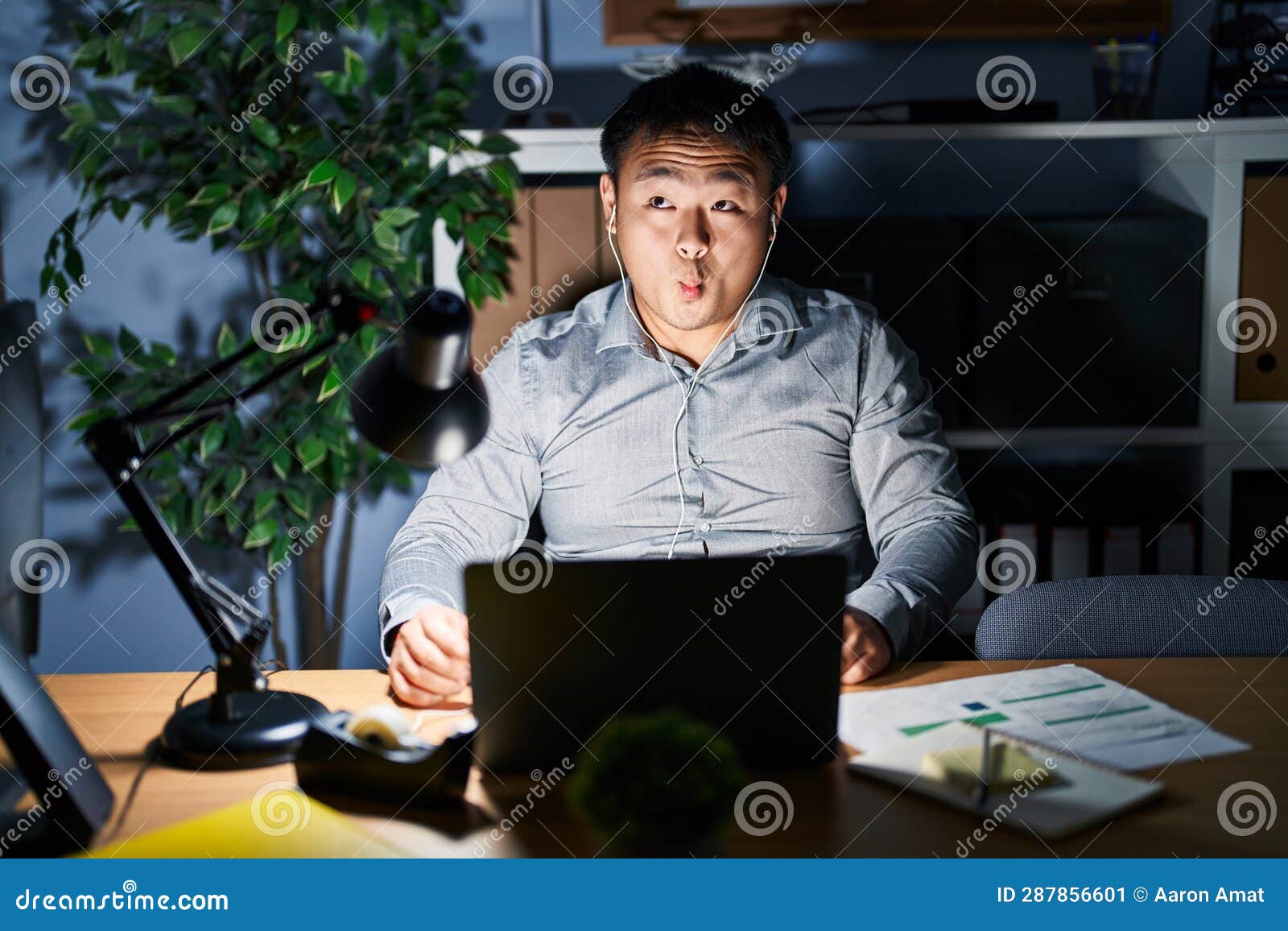 Young Chinese Man Working Using Computer Laptop at Night Making Fish ...