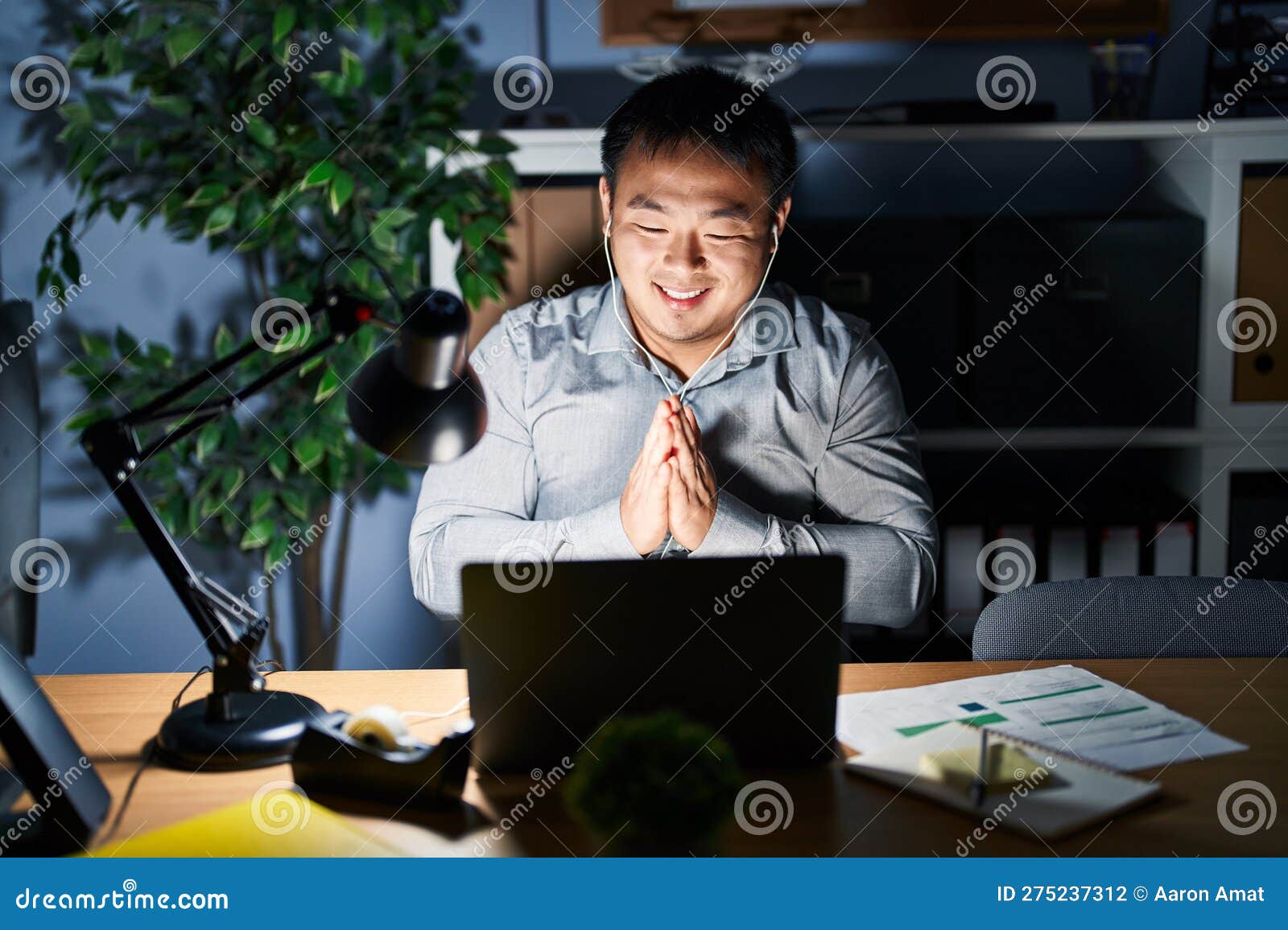 Young Chinese Man Working Using Computer Laptop at Night Praying with ...