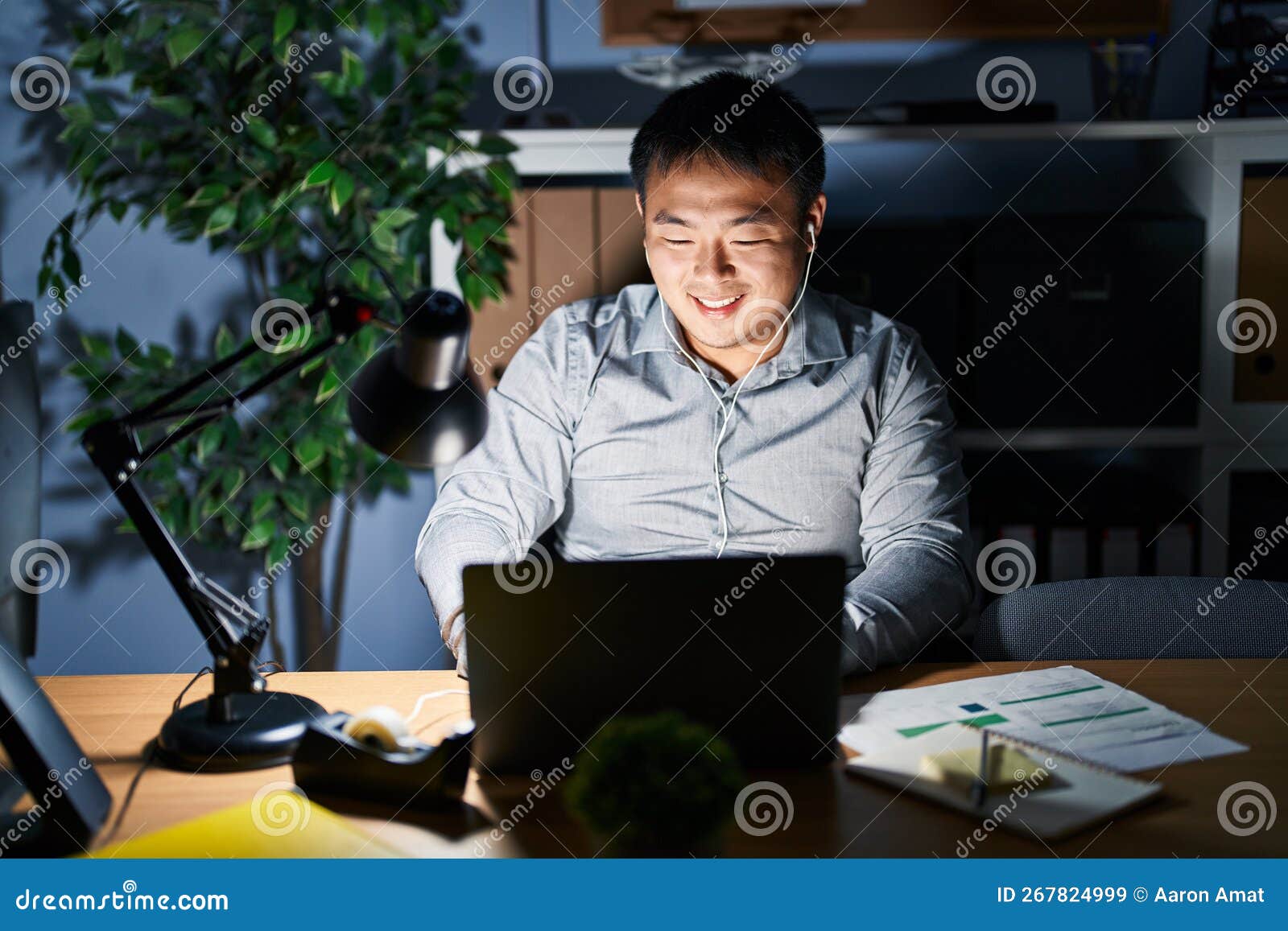 Young Chinese Man Working Using Computer Laptop at Night Winking ...