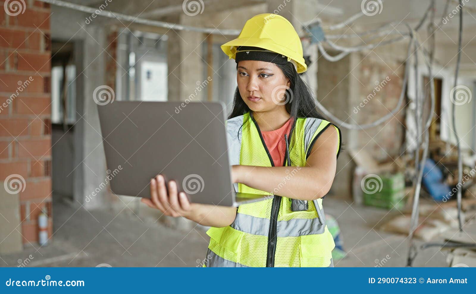 Young Chinese Woman Architect Using Laptop at Construction Site Stock ...