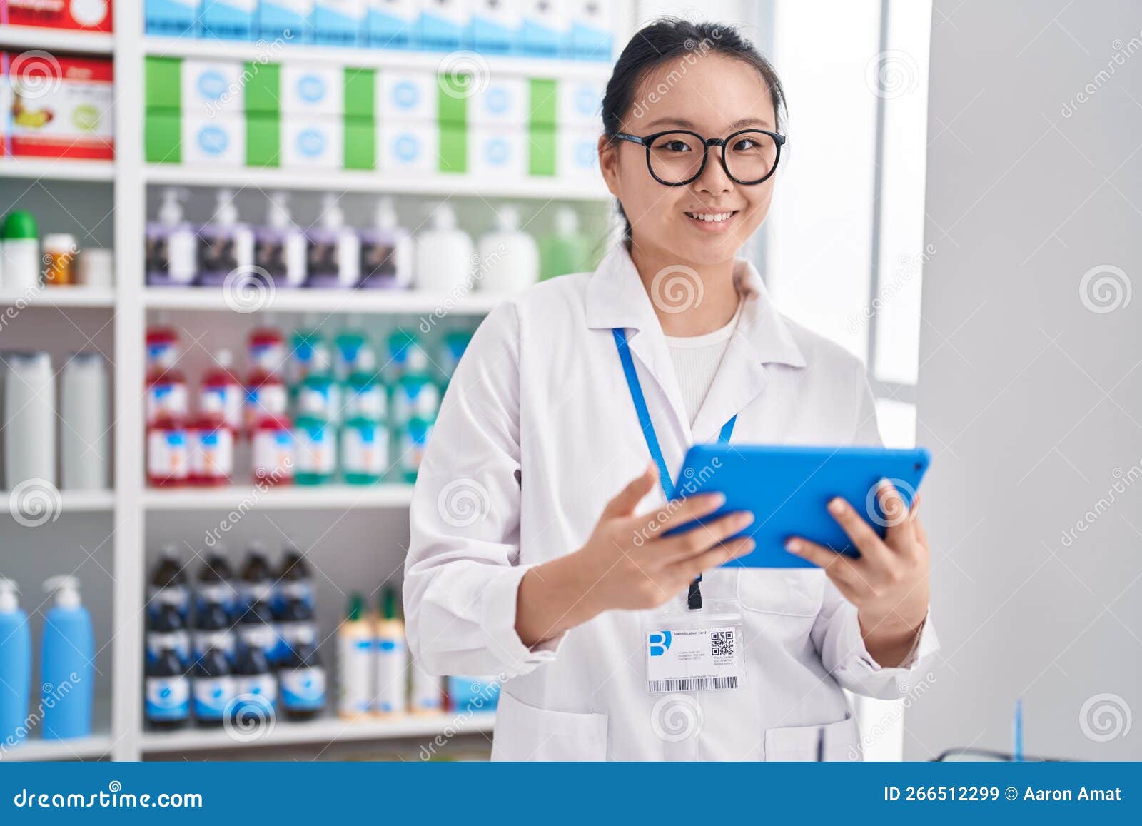 Young Chinese Woman Pharmacist Using Touchpad Working at Pharmacy Stock ...