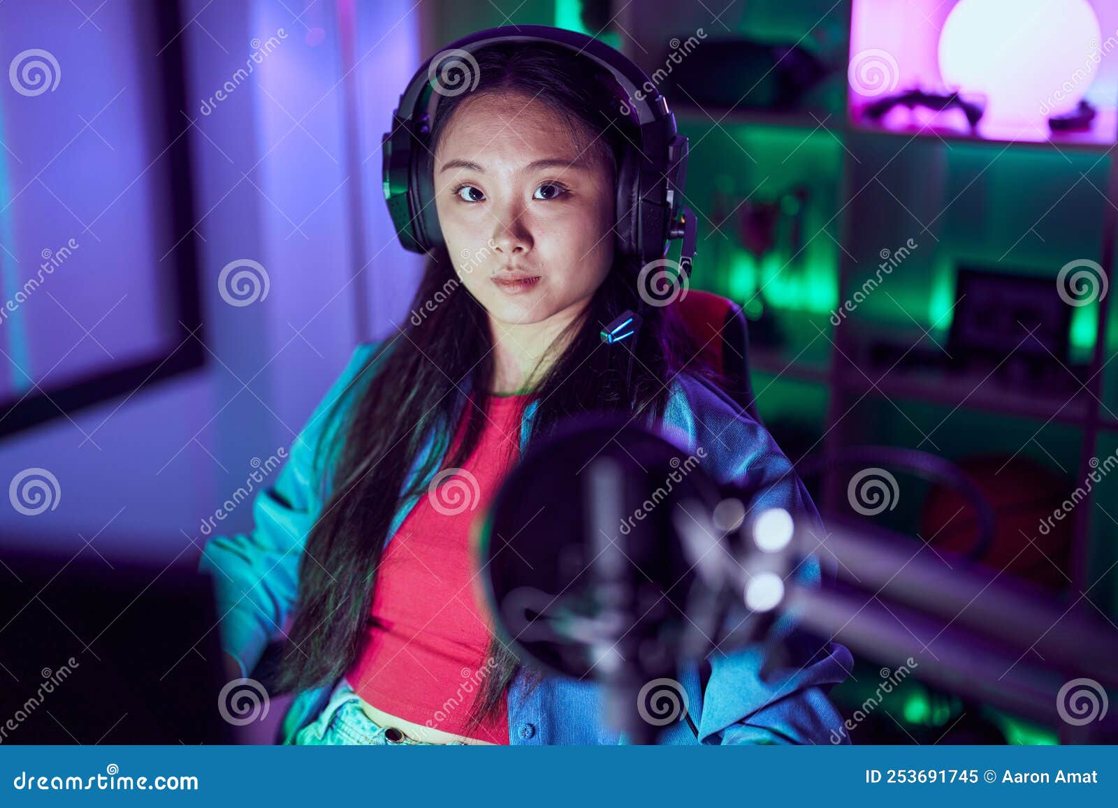 Young Chinese Woman Streamer Playing Video Game Using Computer at ...