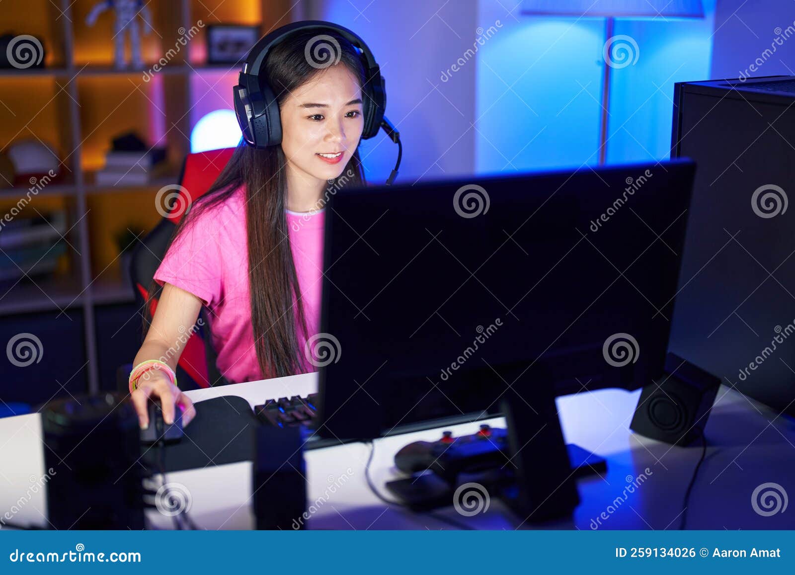 Young Chinese Woman Streamer Playing Video Game Using Computer at ...