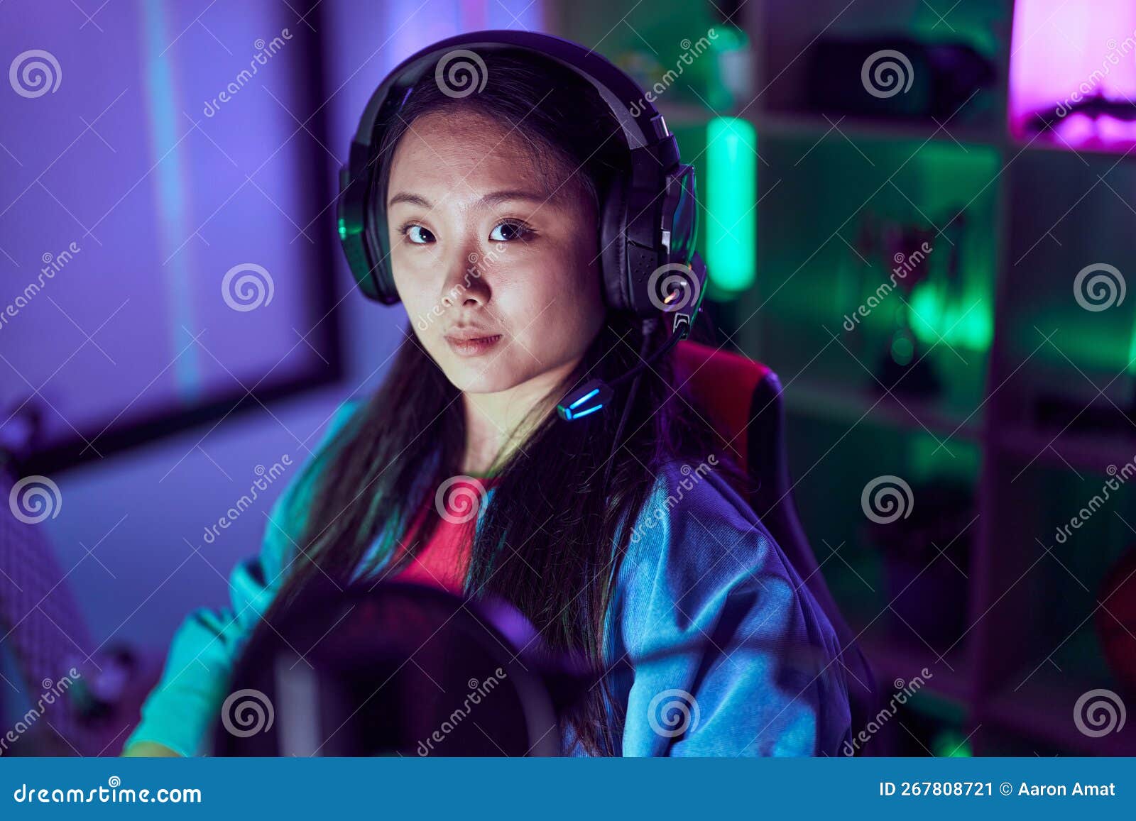 Young Chinese Woman Streamer Playing Video Game Using Computer at ...