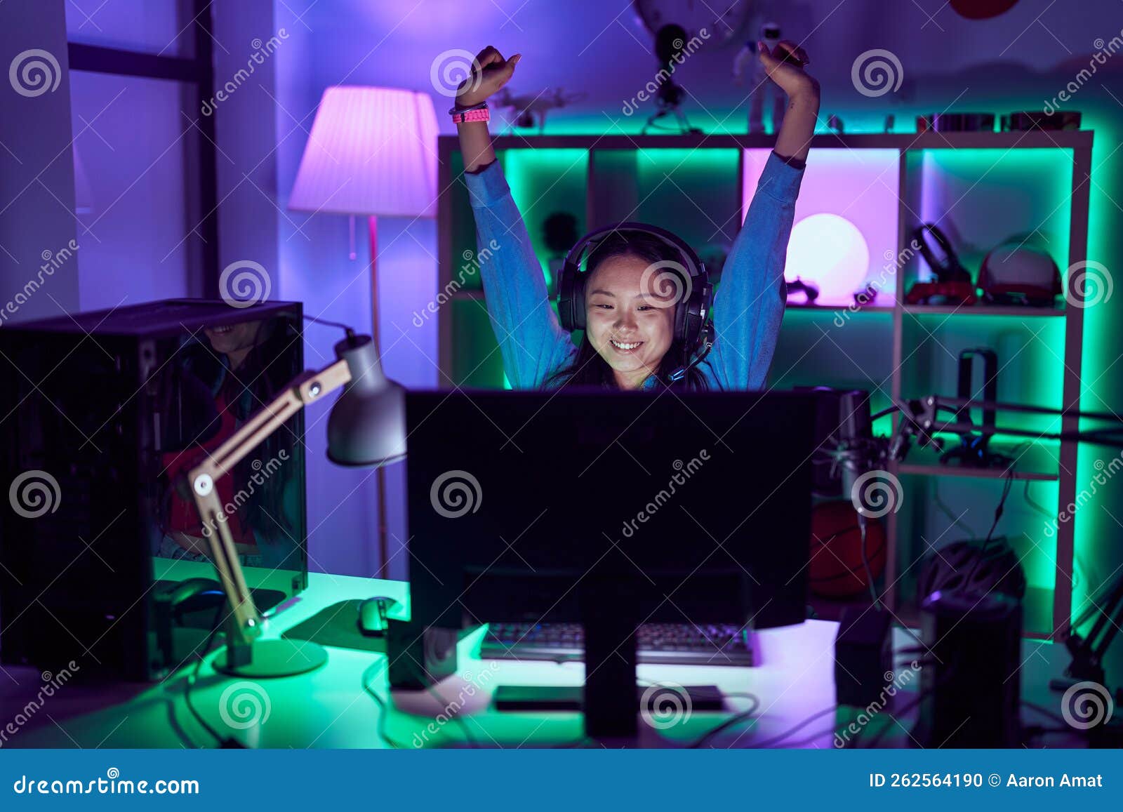 Young Chinese Woman Streamer Using Computer with Winner Expression at ...