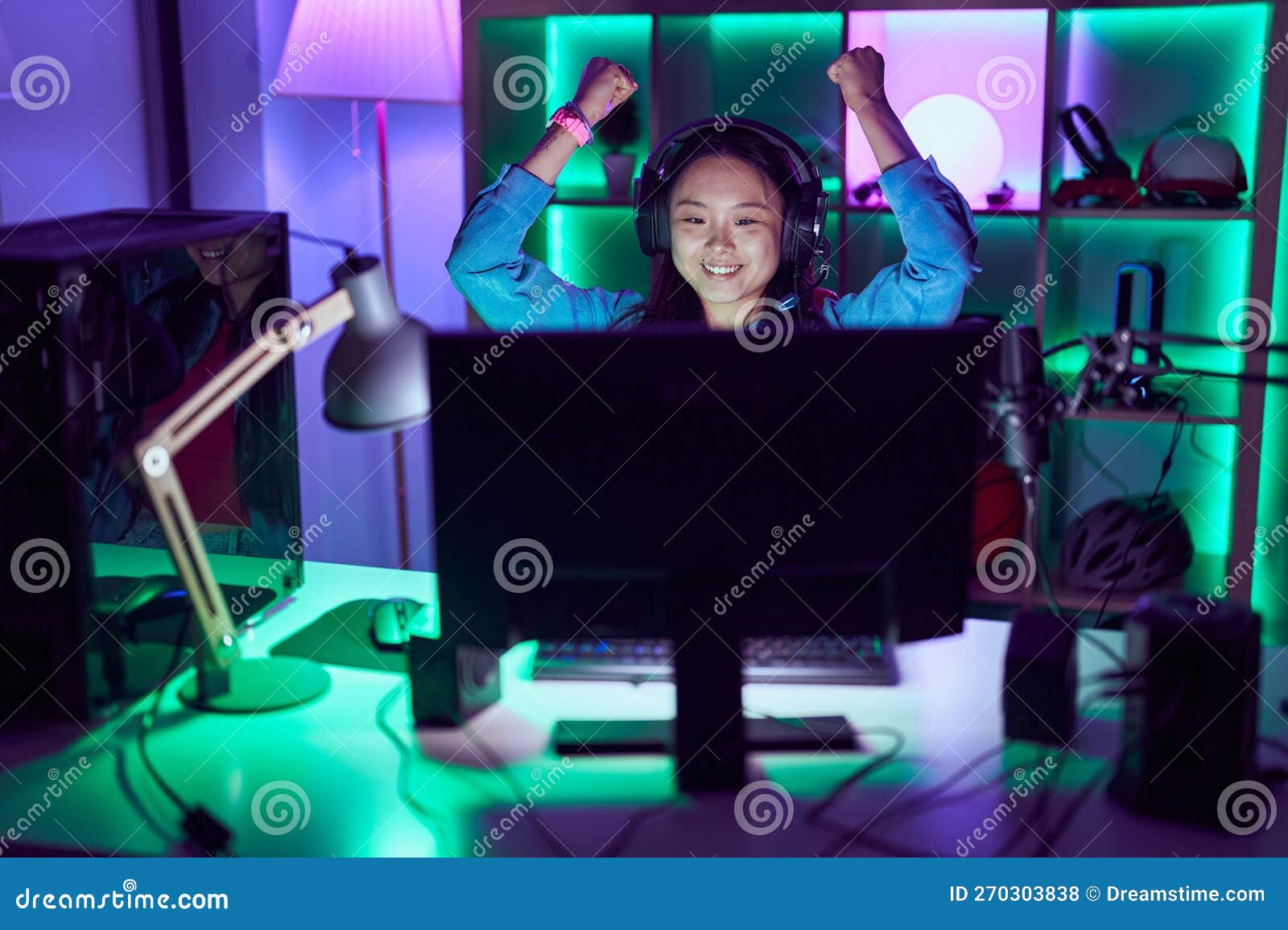 Young Chinese Woman Streamer Using Computer with Winner Expression at ...