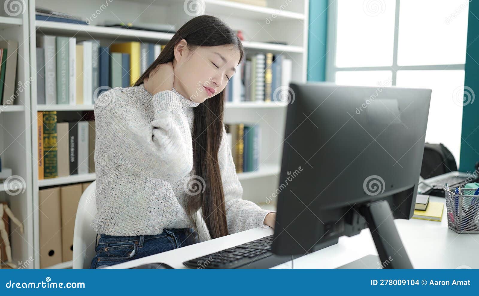 Young Chinese Woman Student Using Computer Stressed at Library ...
