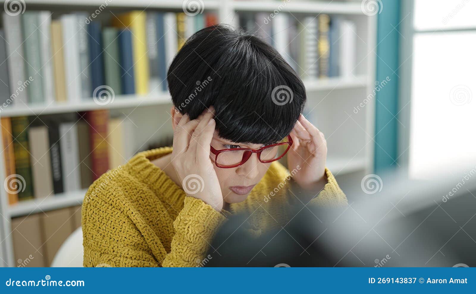 Young Chinese Woman Student Using Computer Stressed at Library ...