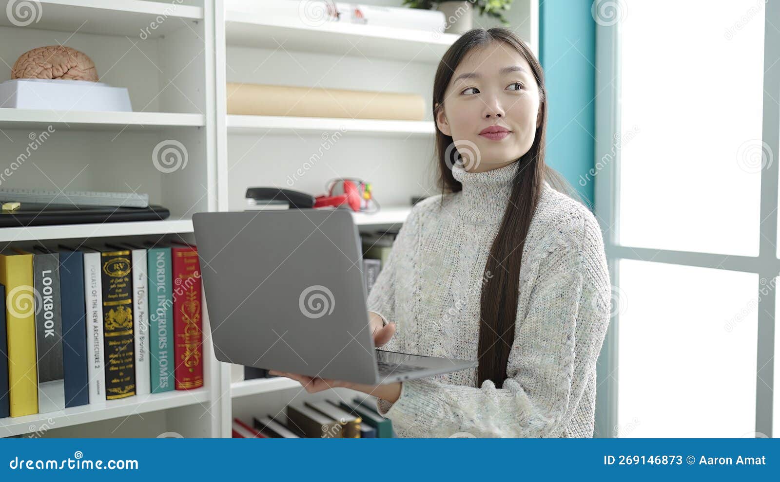 Young Chinese Woman Student Using Laptop Studying at Library University ...