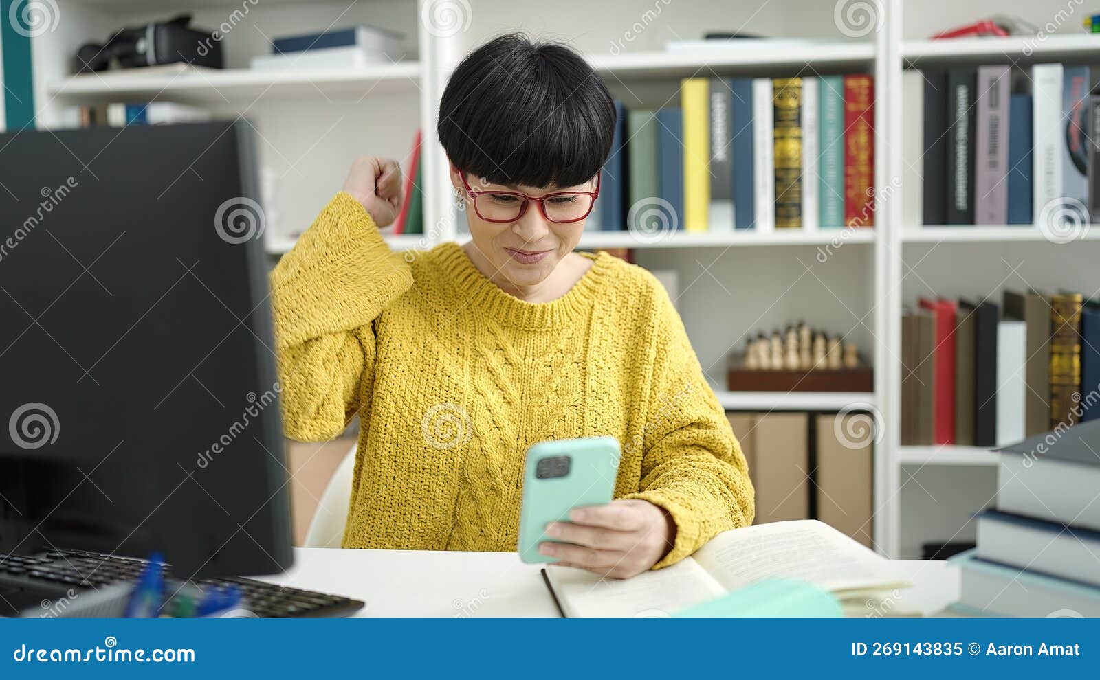 Young Chinese Woman Student Using Smartphone with Winner Expression at ...
