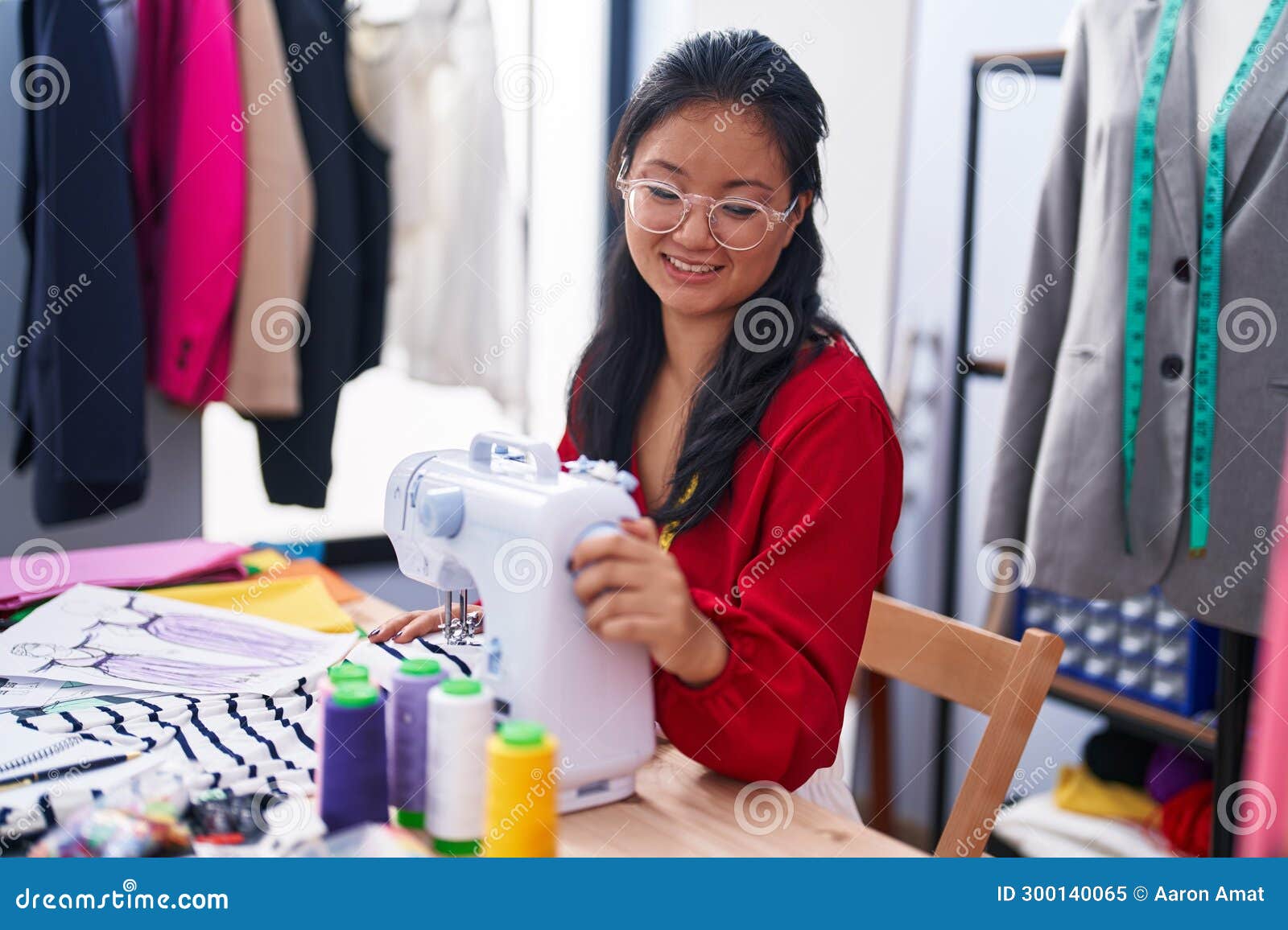 Young Chinese Woman Tailor Smiling Confident Using Sewing Machine at ...