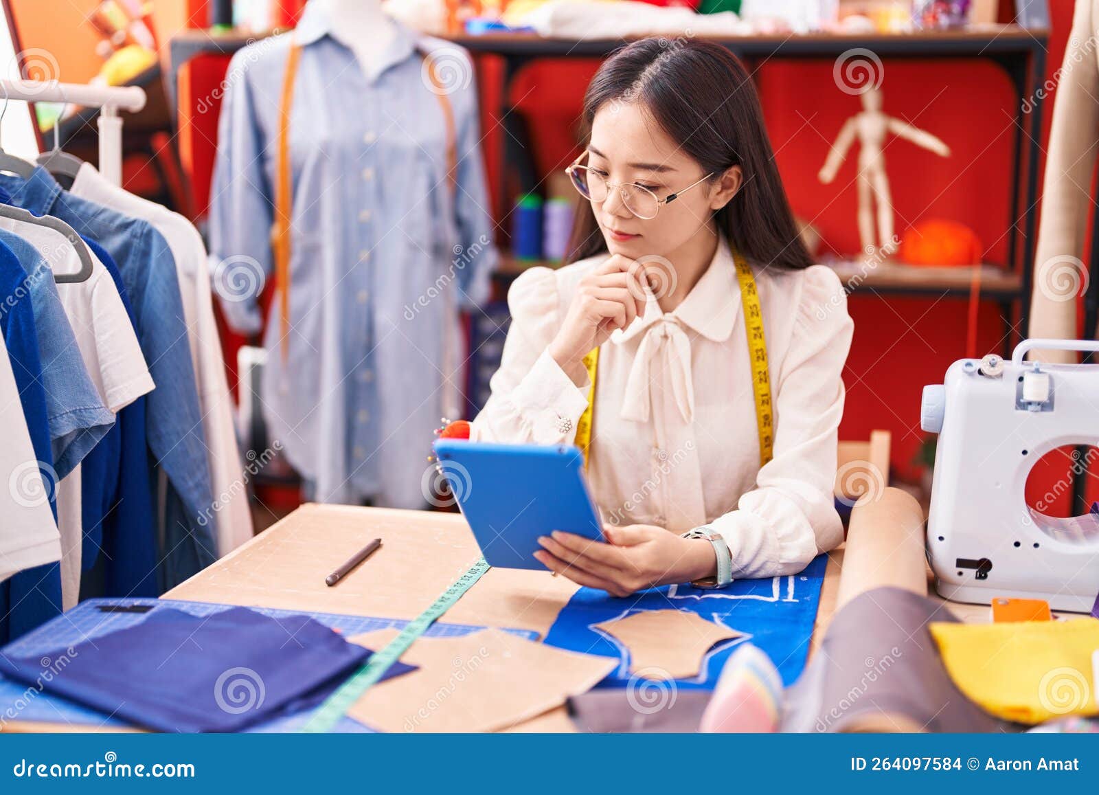 Young Chinese Woman Tailor Smiling Confident Using Touchpad at Atelier ...