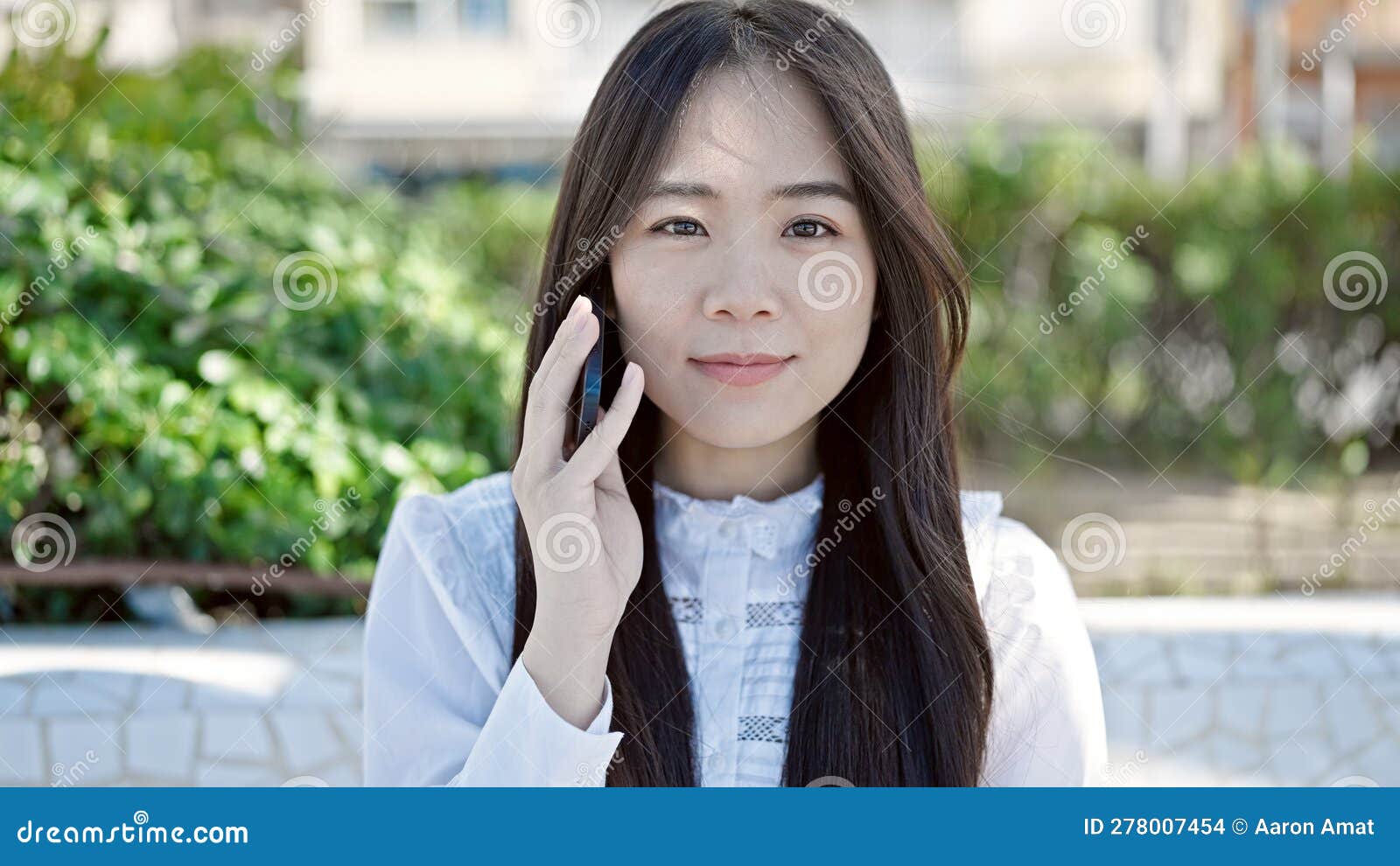 Young Chinese Woman Talking on Smartphone with Serious Expression at ...