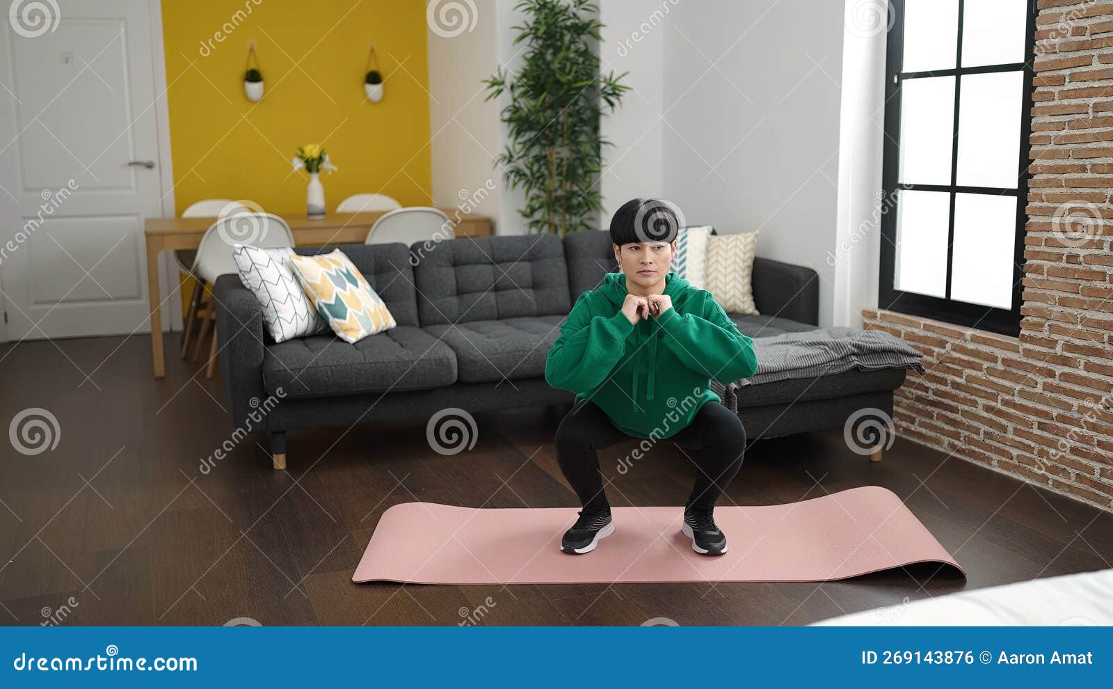 Young Chinese Woman Training Legs Exercise Standing at Home Stock Photo ...