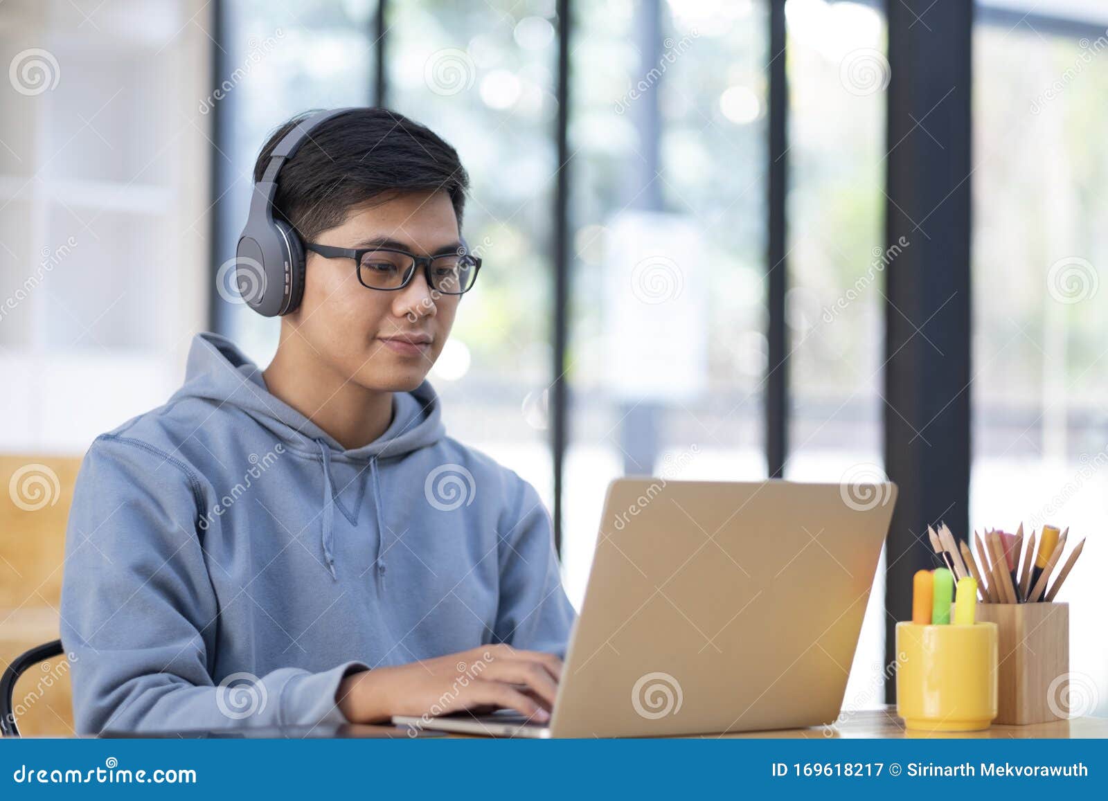 Young Collage Student Using Computer and Mobile Device Studying Online ...